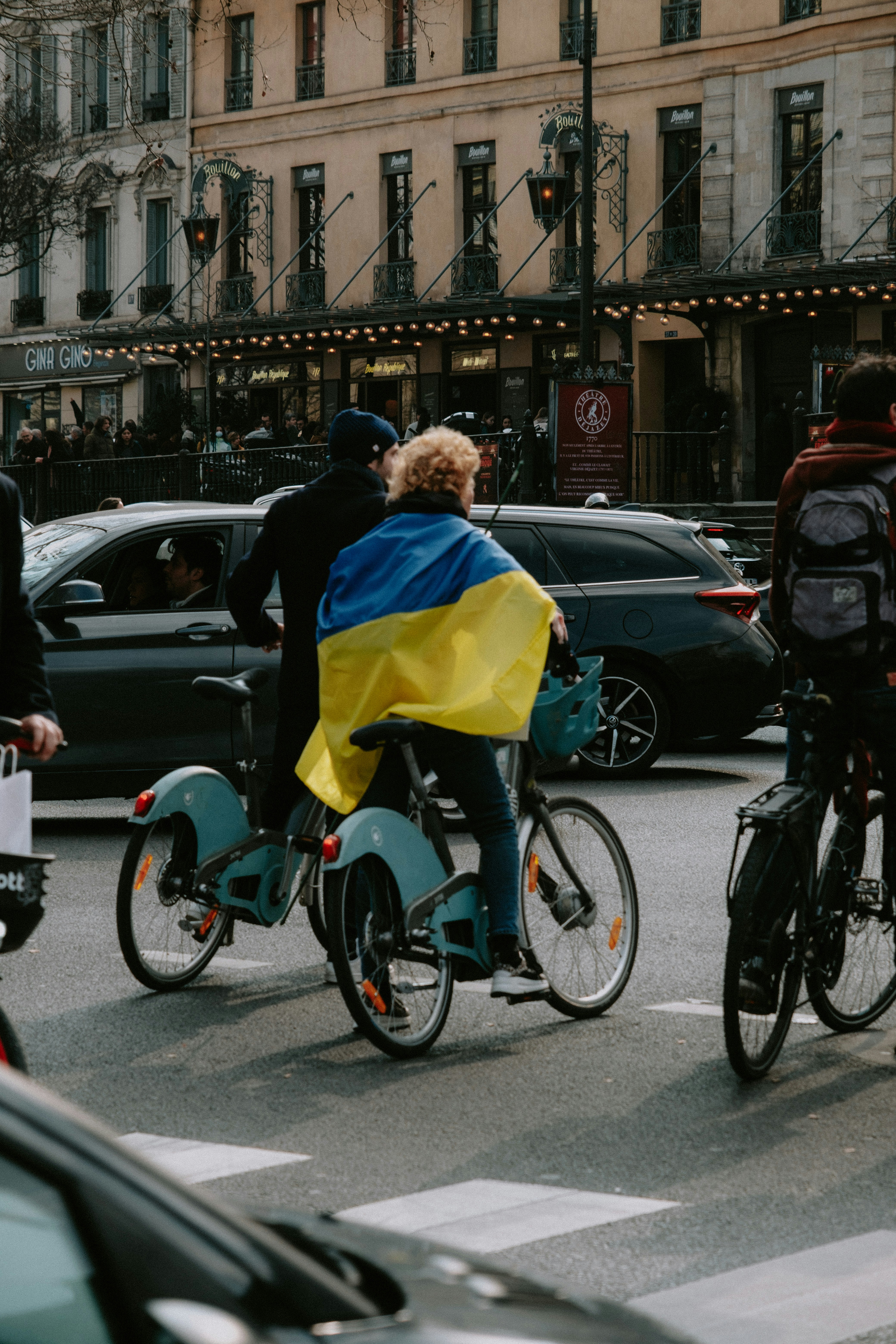 A group of people riding bikes down a street photo – Free Place de la ...