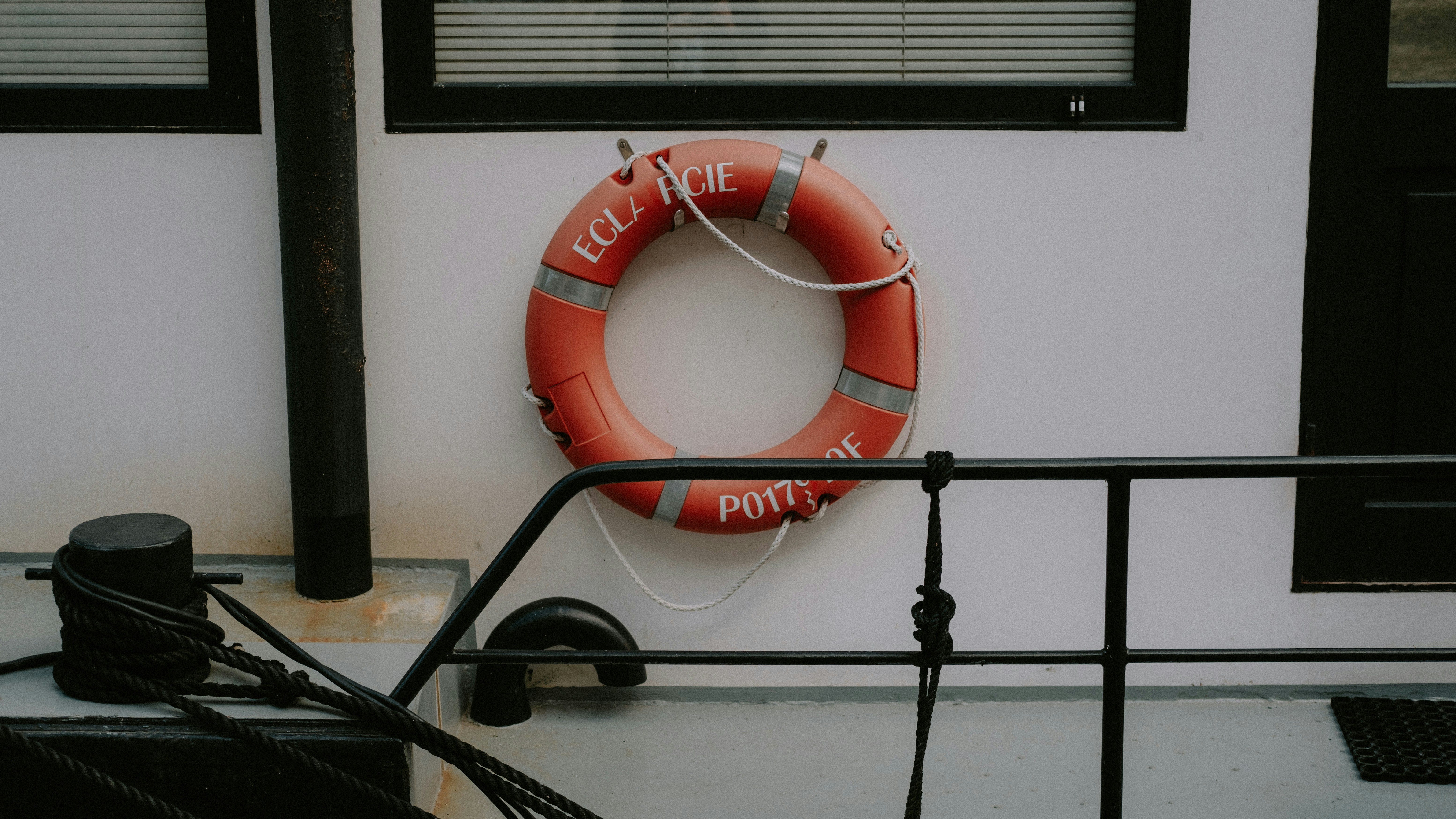 A life preserver hanging on the side of a building photo – Free Paris ...