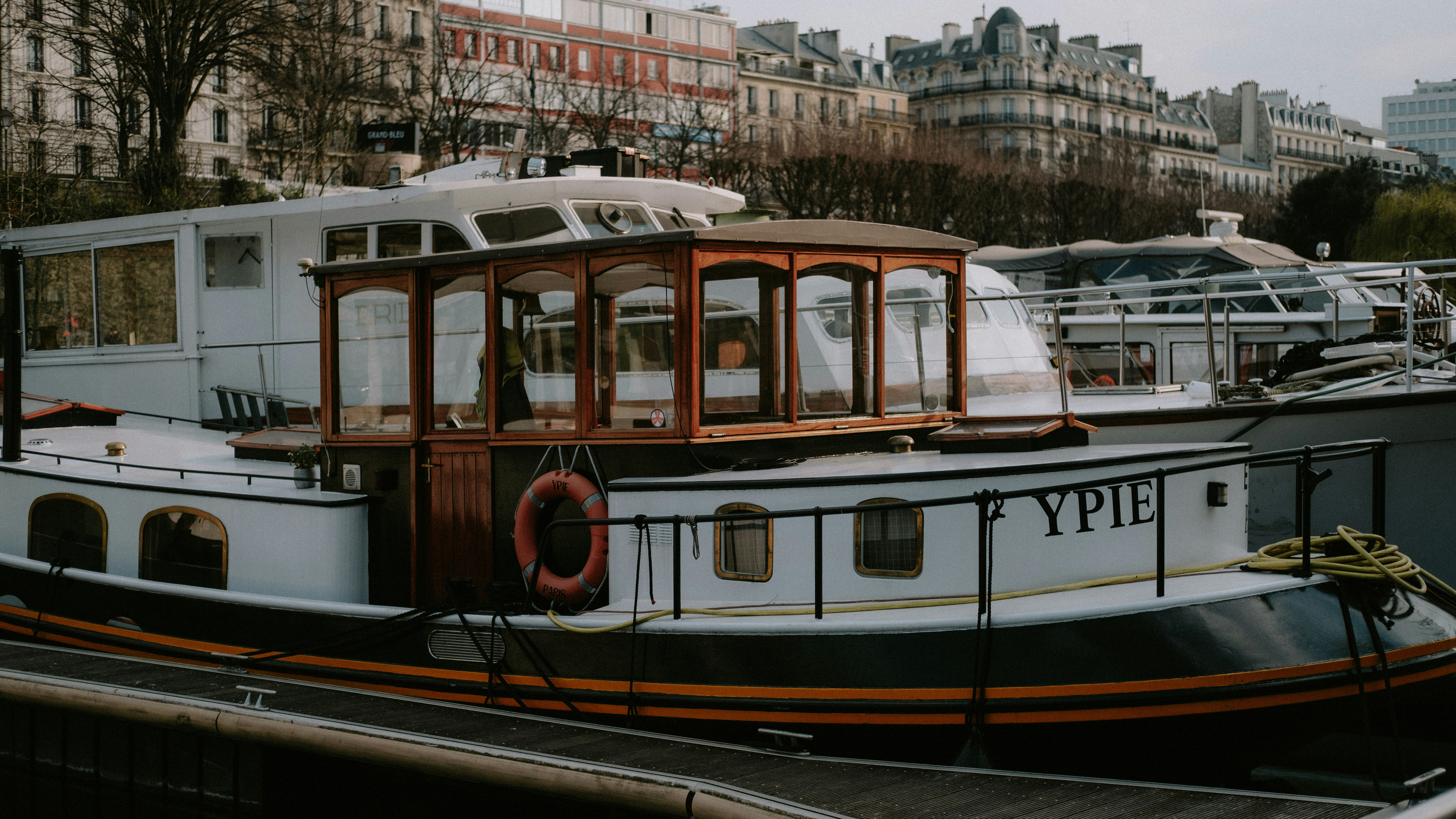 Wharfed Vessel: A Classic Boat moored along a Parisian Riverfront