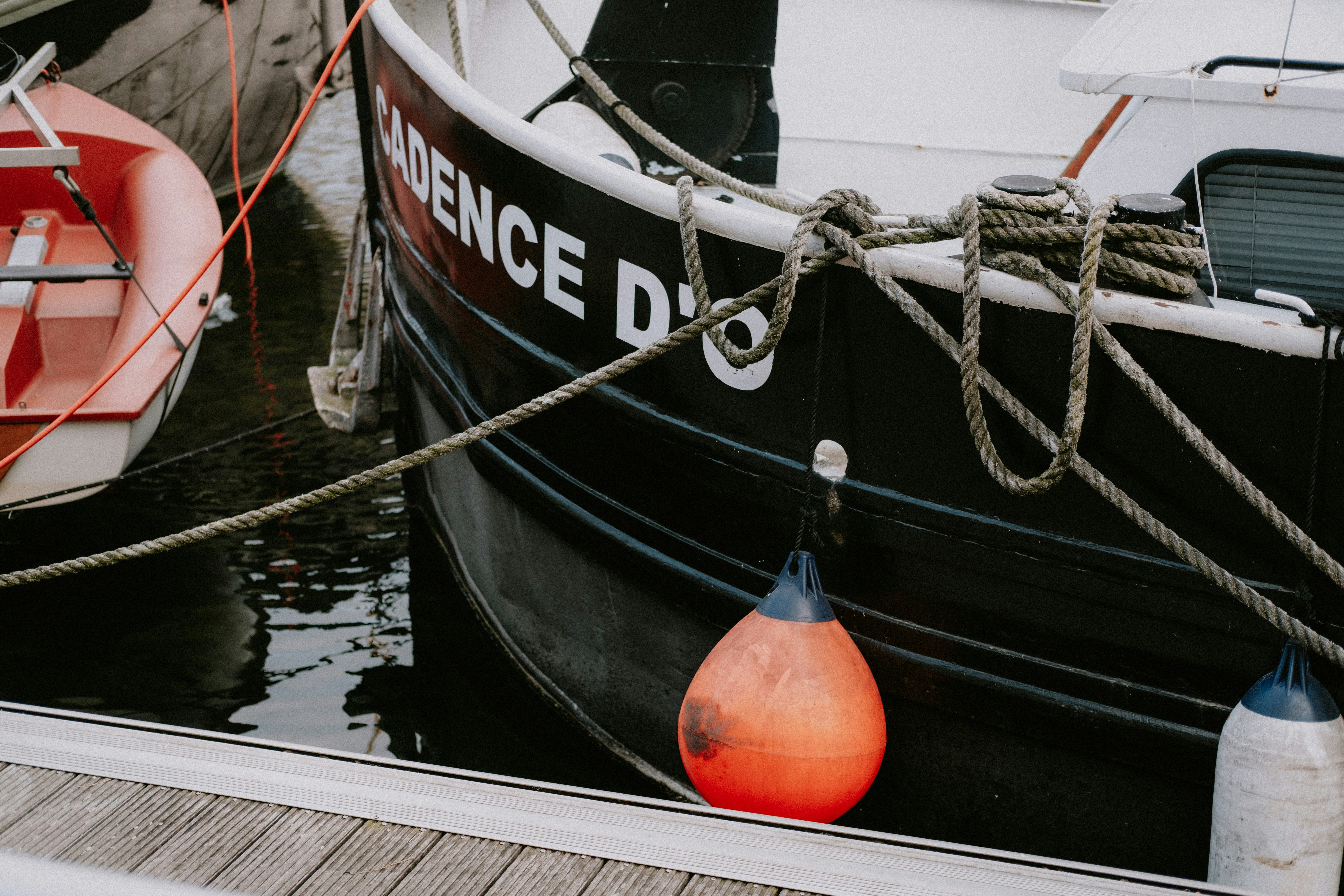 A boat tied up to a dock next to another boat photo – Free France Image ...