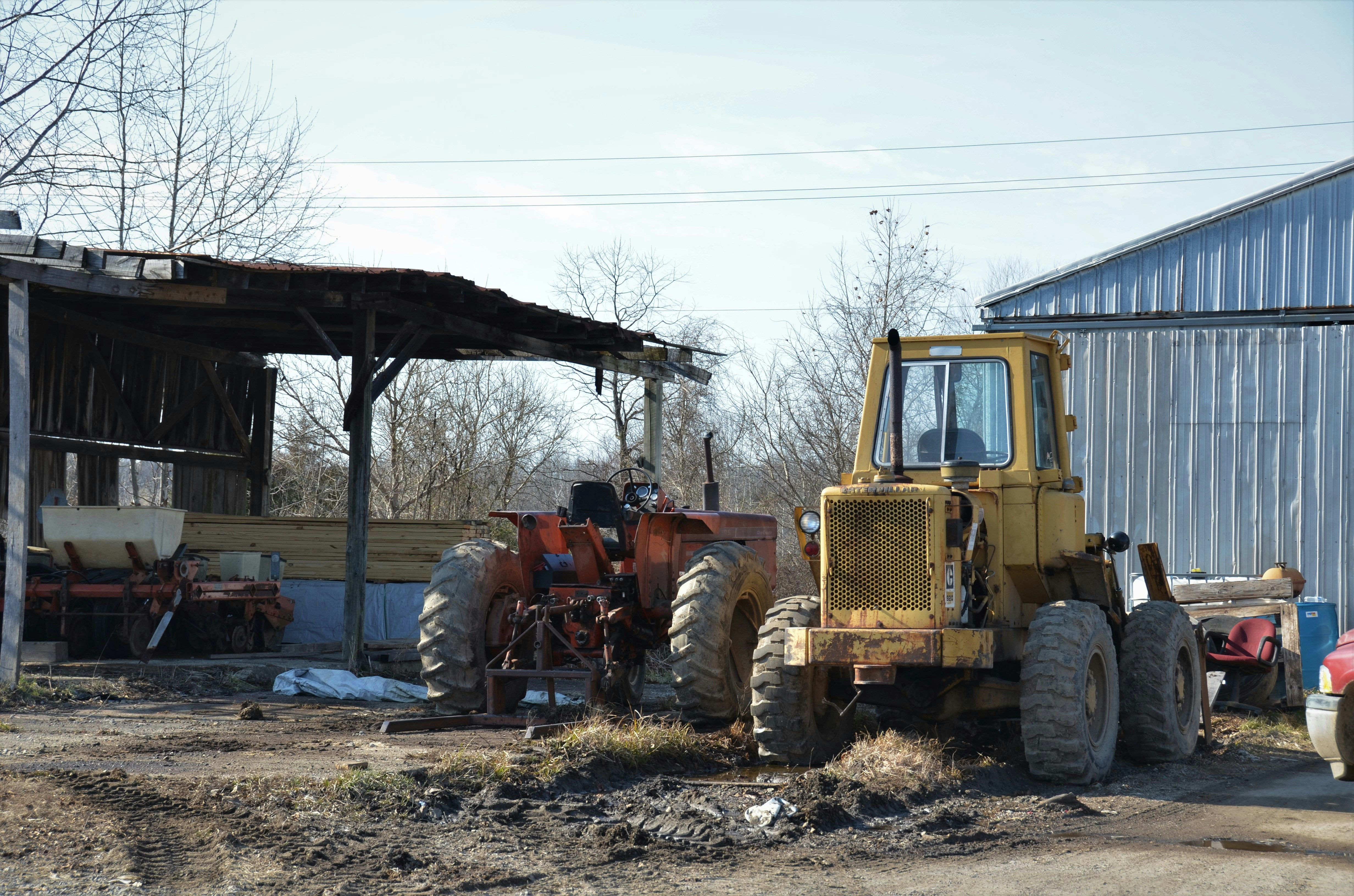 A tractor parked in front of a building photo – Free Nature Image on ...