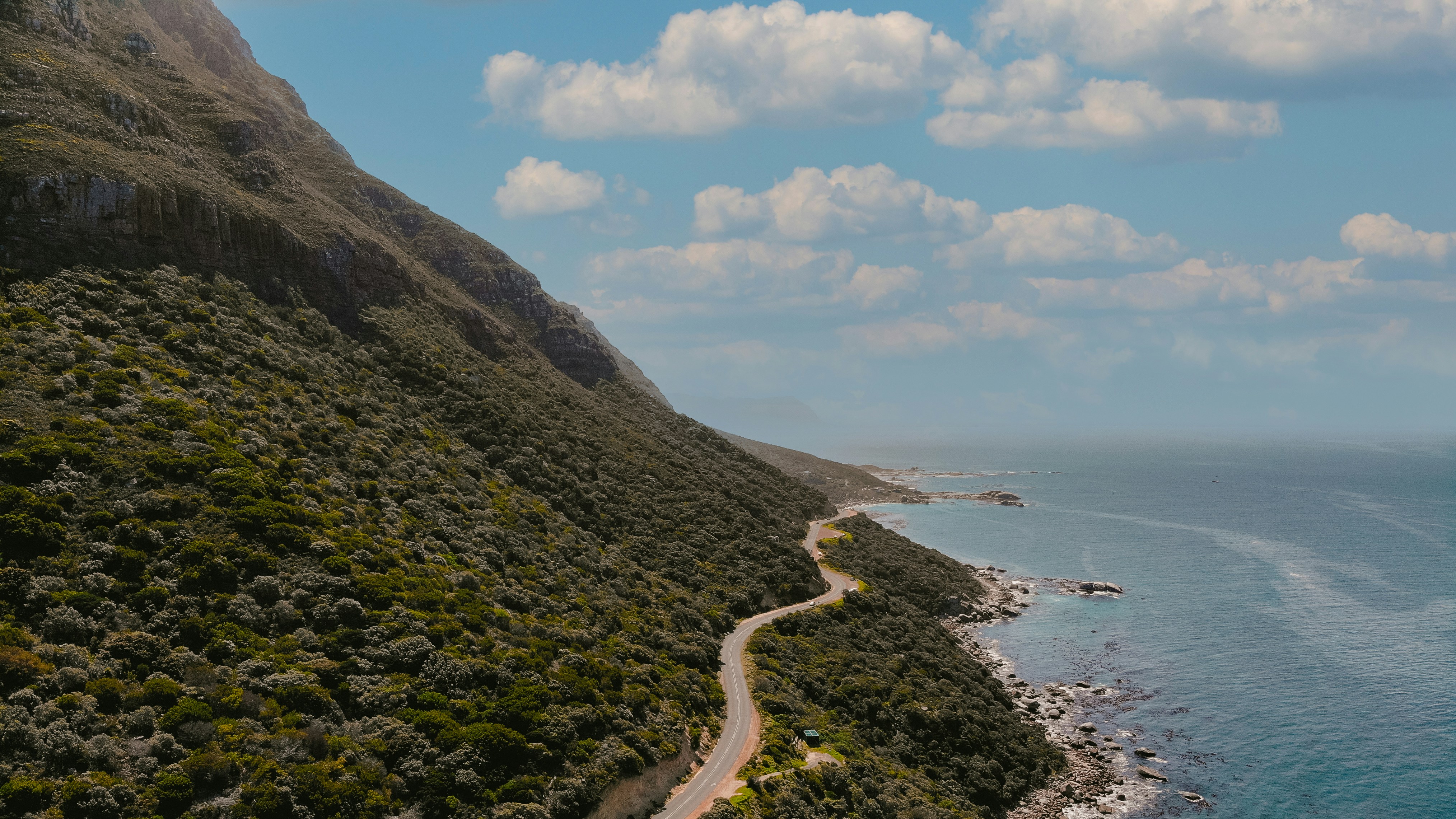 A scenic view of a winding road near the ocean photo – Free Grey Image ...
