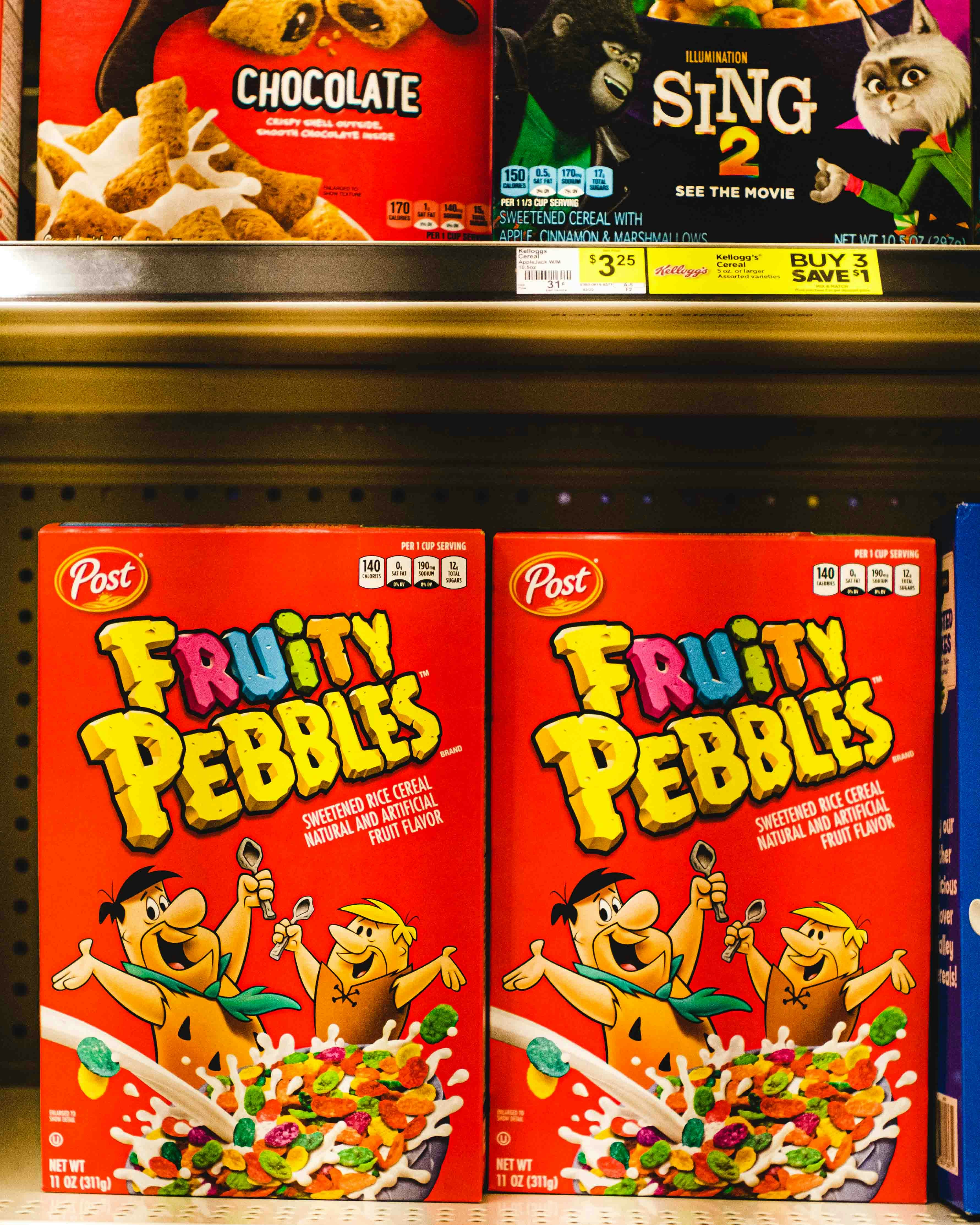 A row of cereal boxes sitting on top of a shelf photo – Free Food Image ...