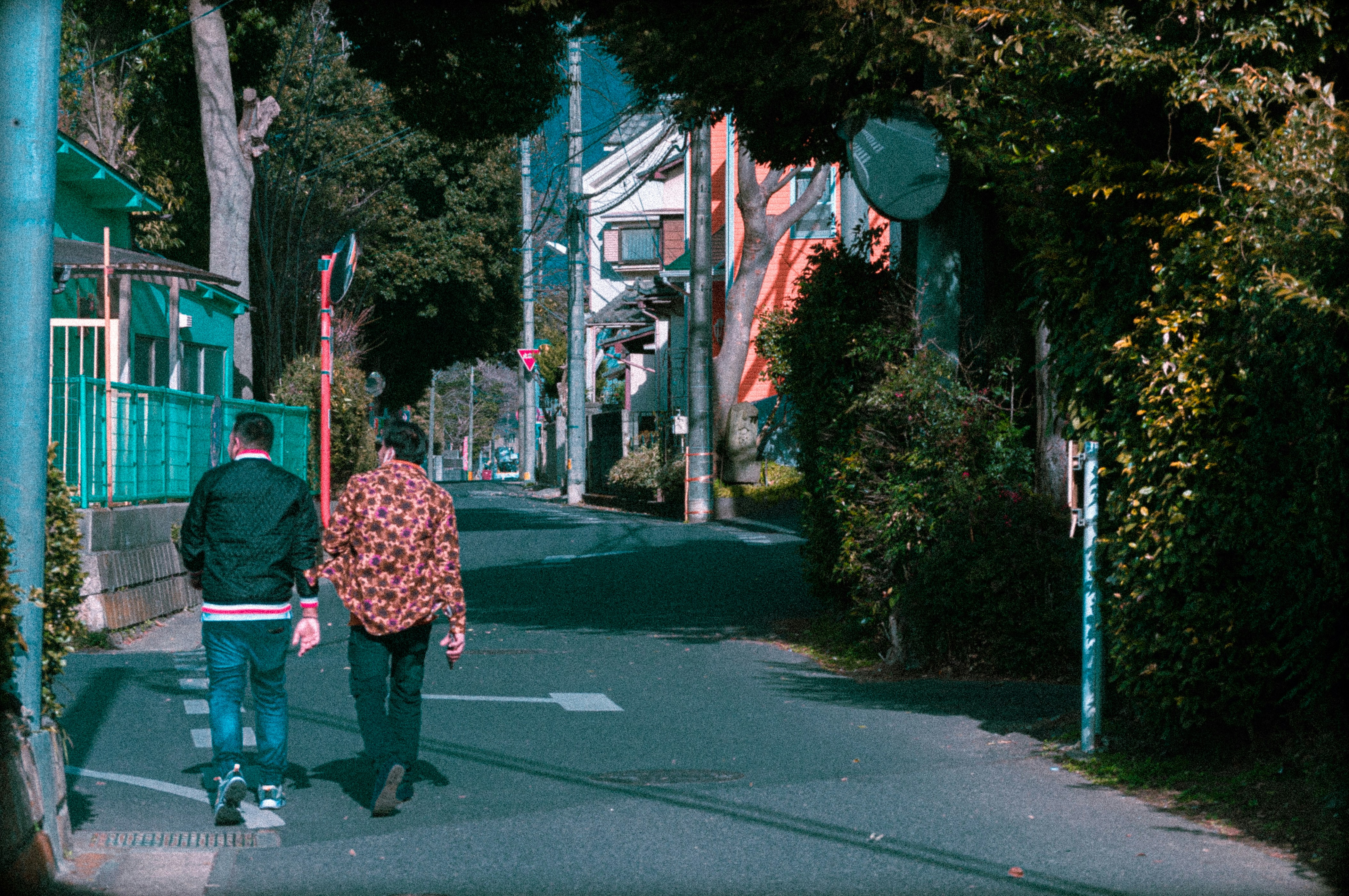 Two friends walking in Japan downtown. | a man and a woman walking down a street