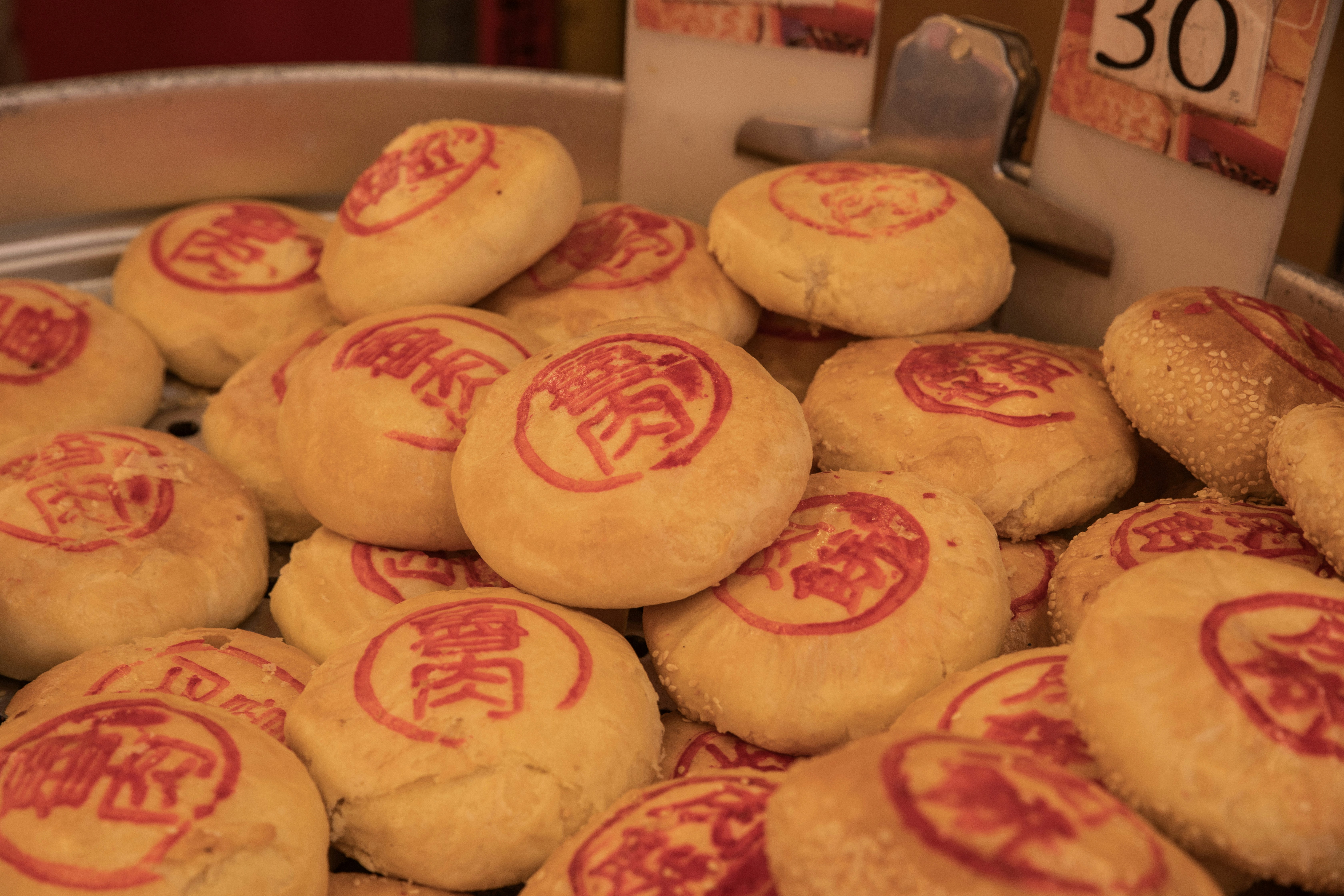 Red-Sealed Buns in a Warm Bakery Cascade