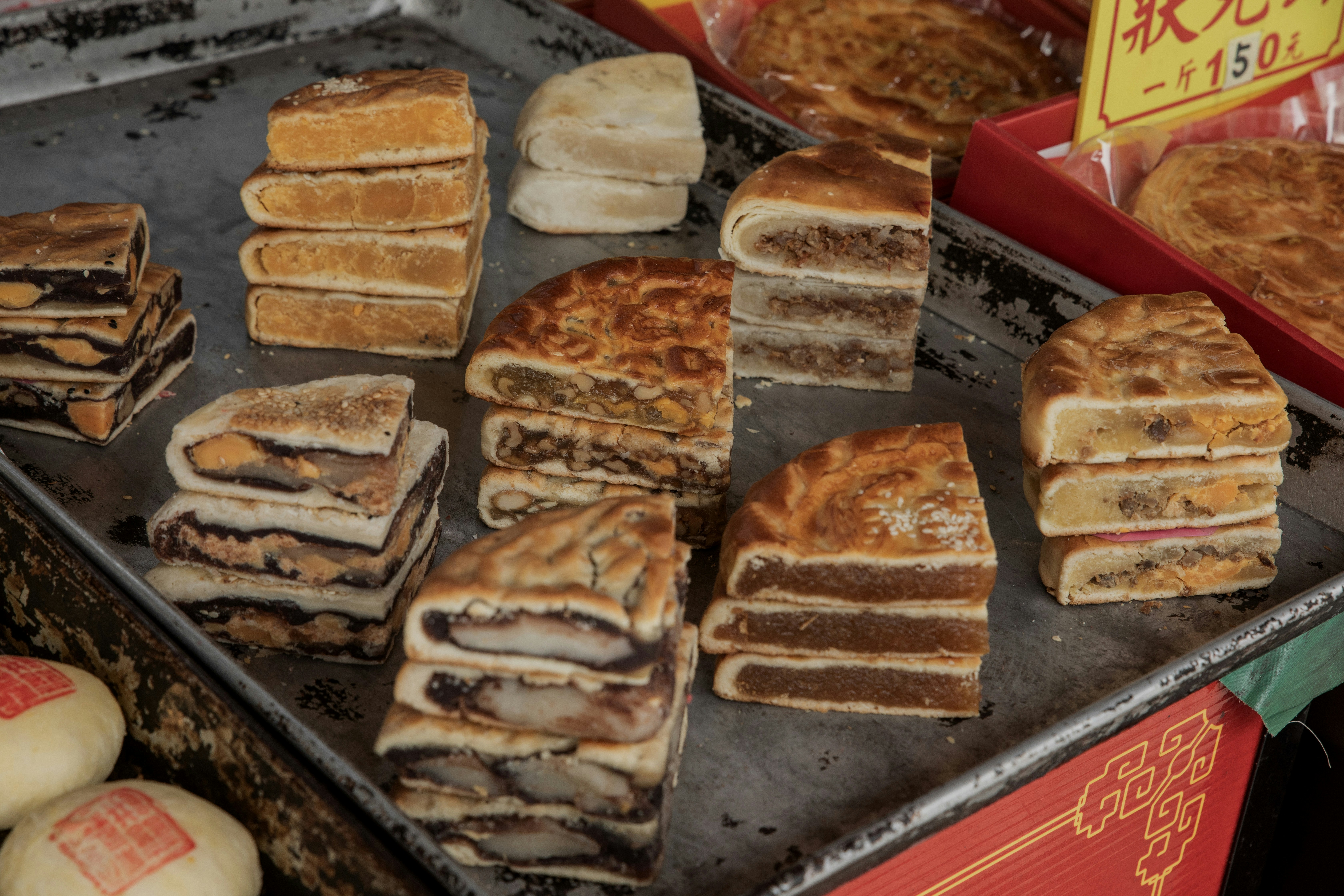 Stacked pastries glow under market lights, inviting a bite
