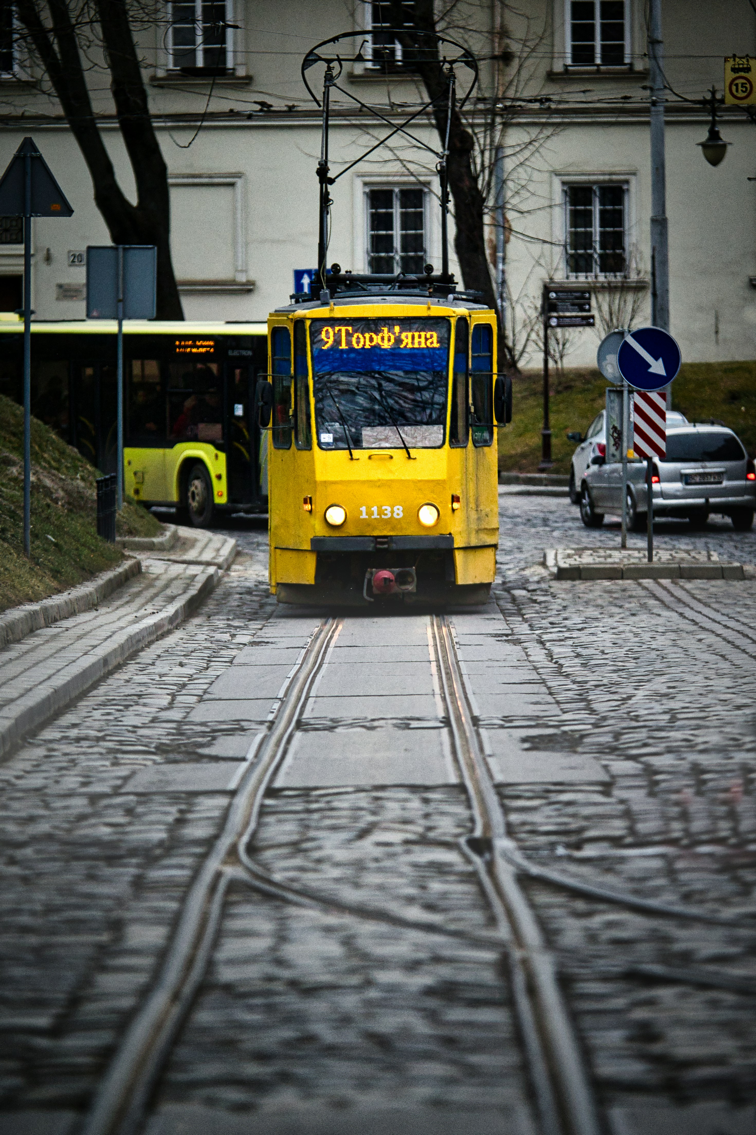 Centred on Rails: The Yellow Tram Traverses a Cobblestone Avenue