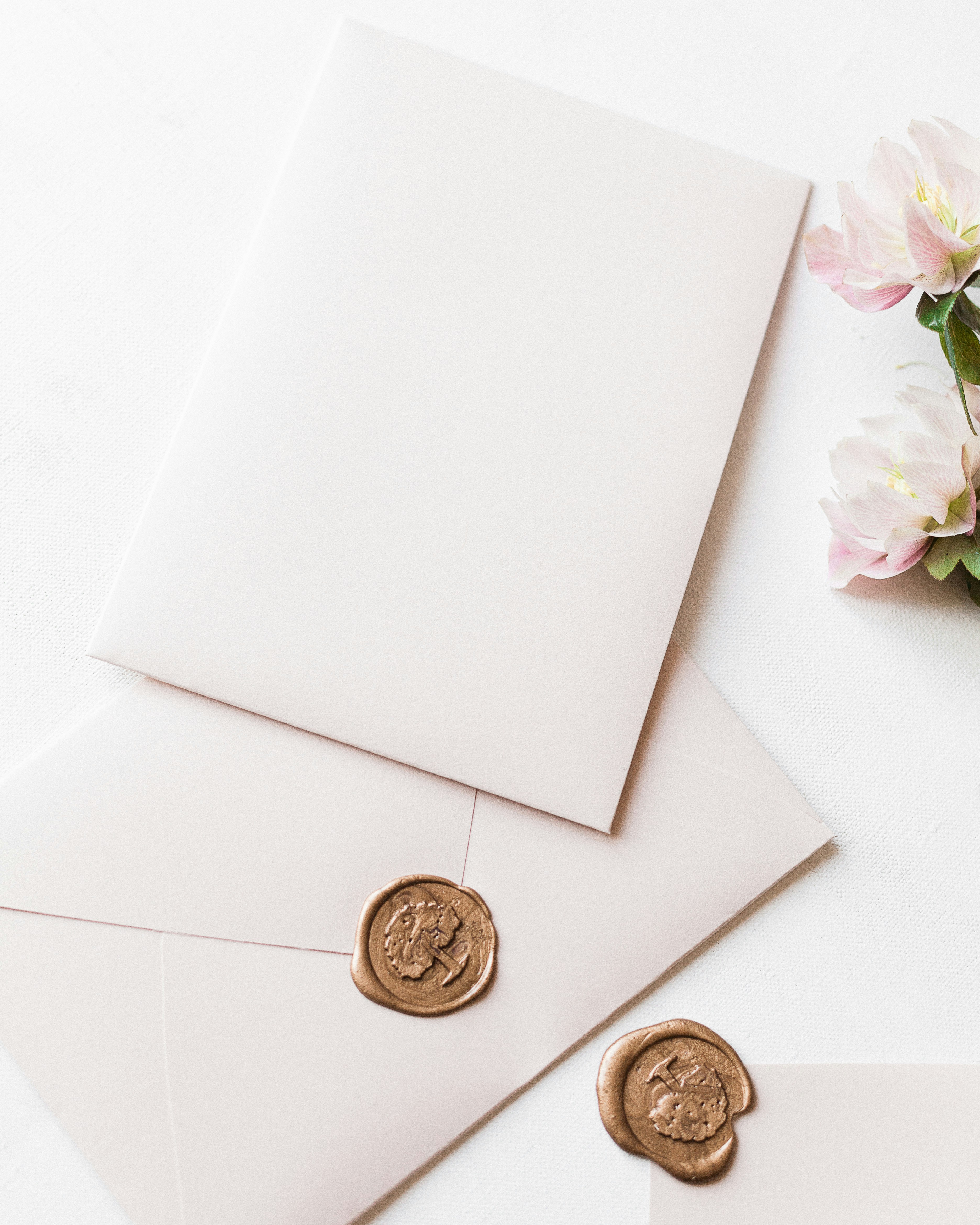 A couple of white envelopes sitting next to each other photo – Free ...