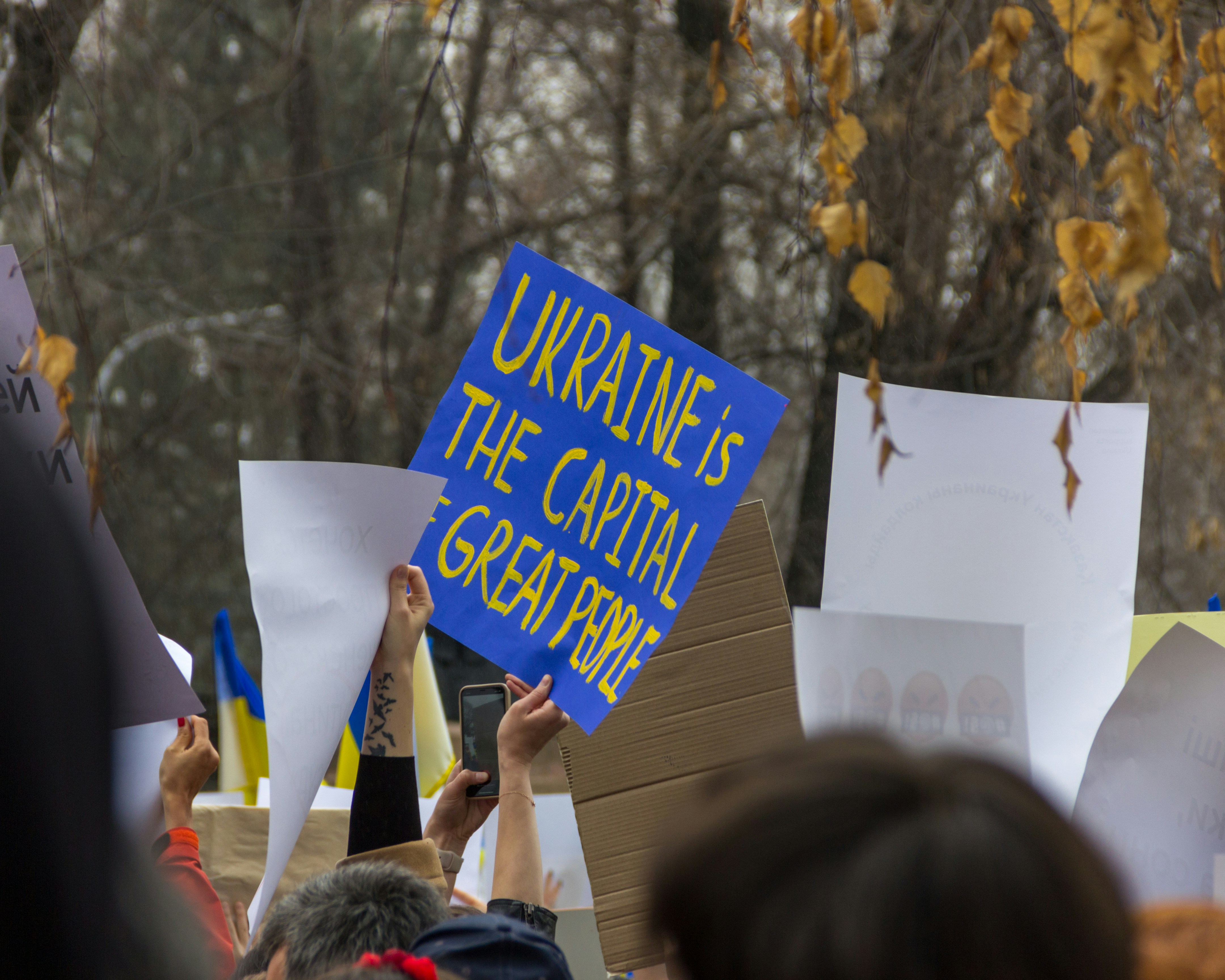 A group of people holding up signs in the air photo – Free Almaty Image ...