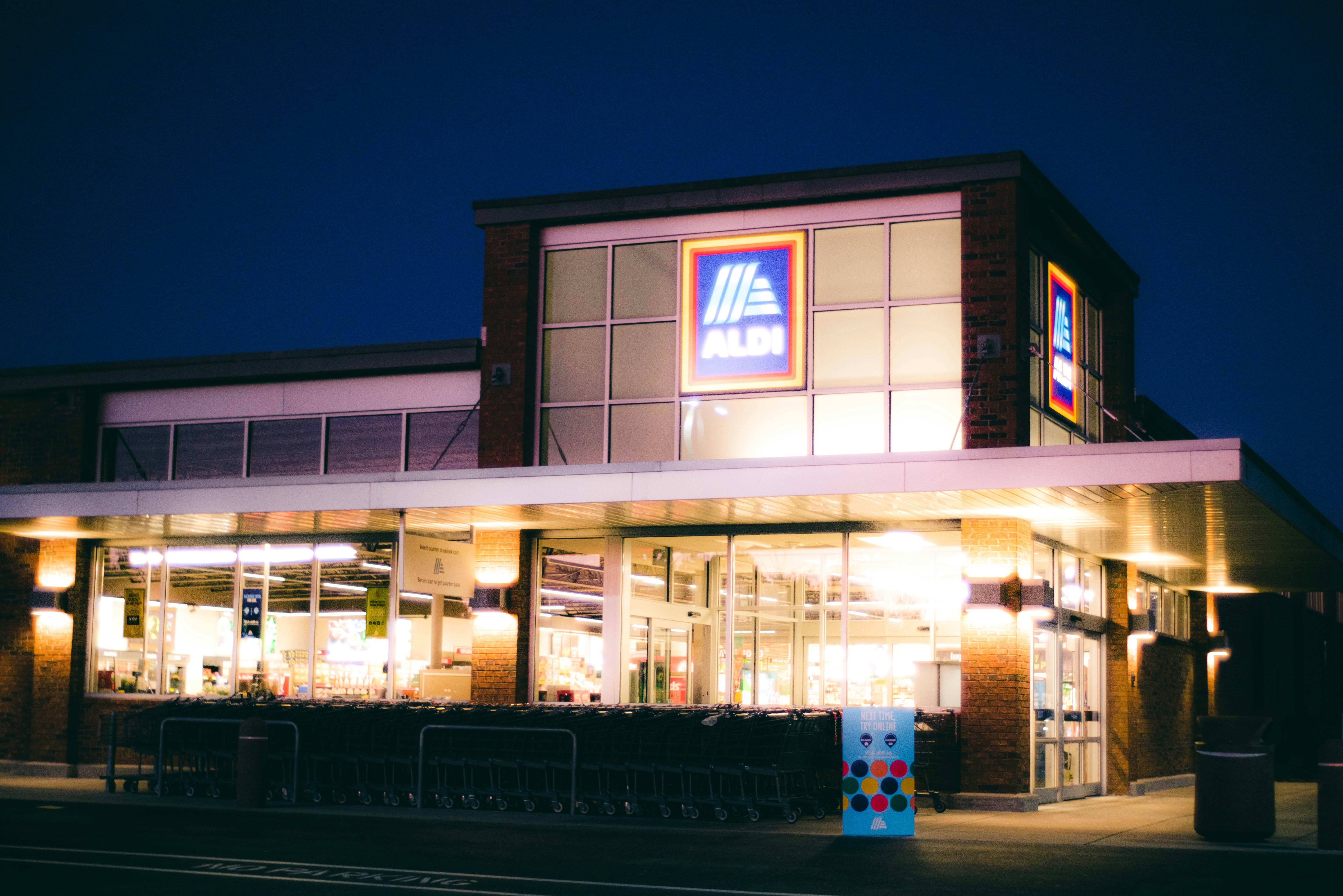 A lit up store front at night with the lights on photo – Free Building ...