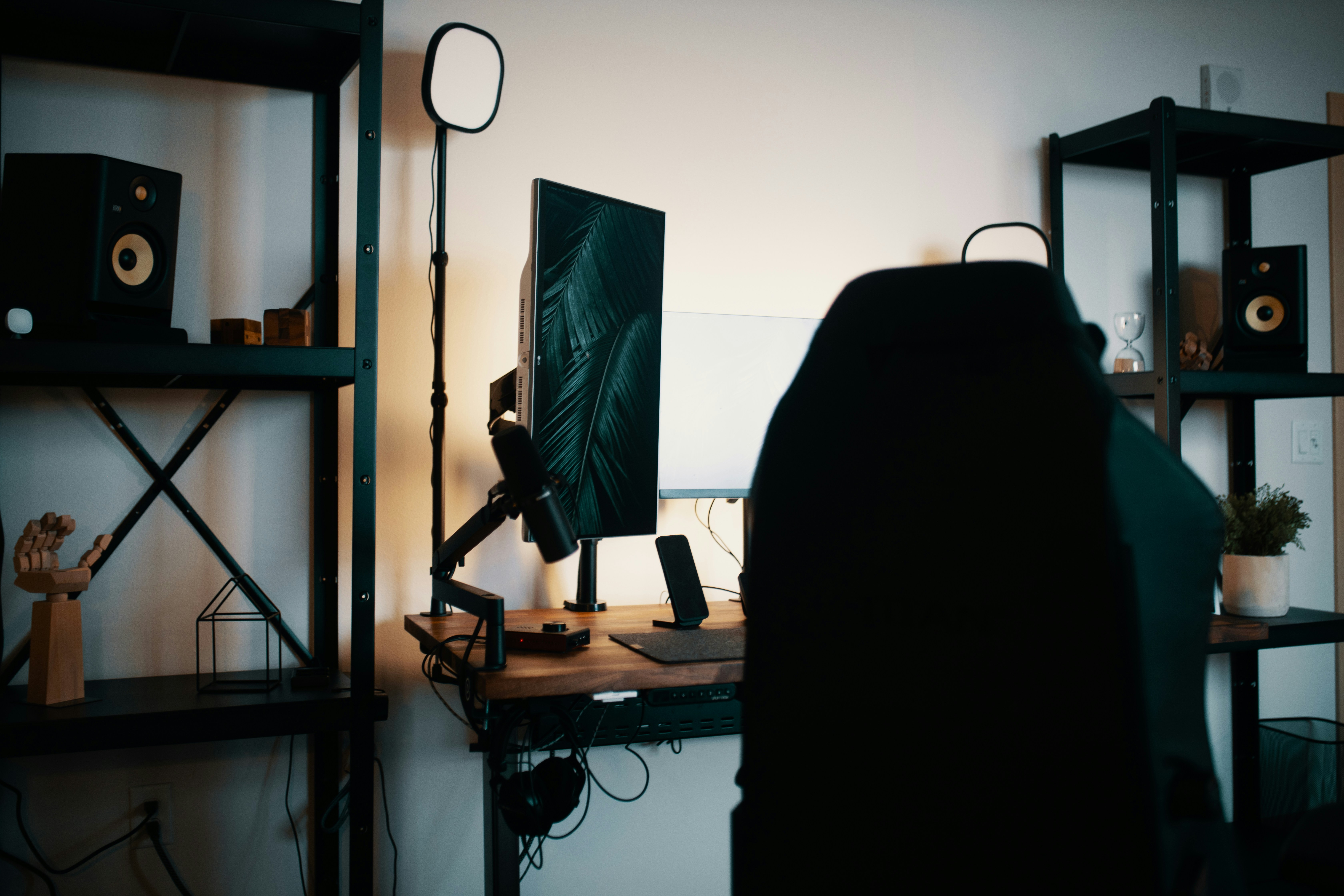 A person standing in front of a computer monitor photo – Free Desk ...
