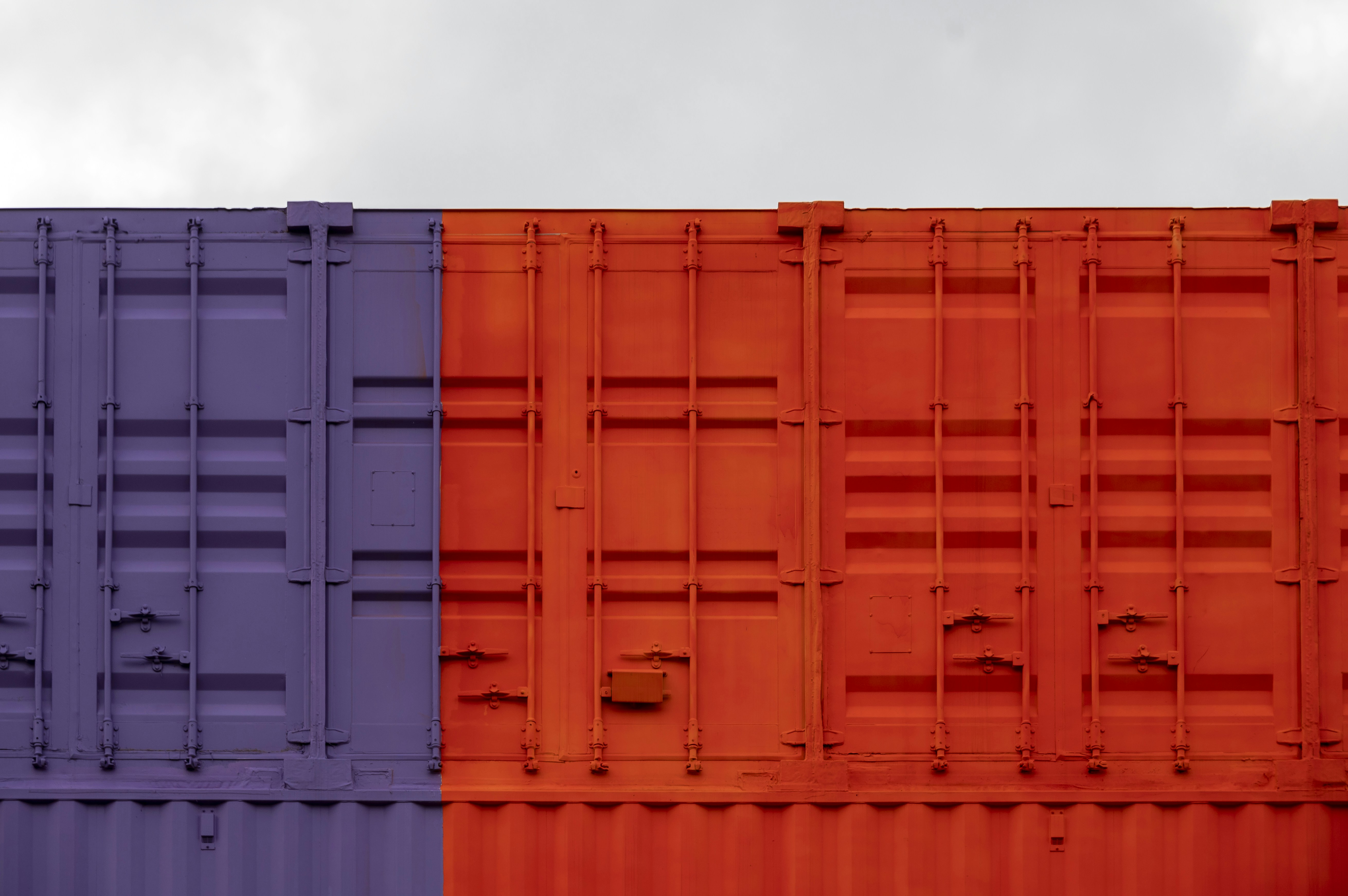 A large orange and purple container sitting next to each other photo ...