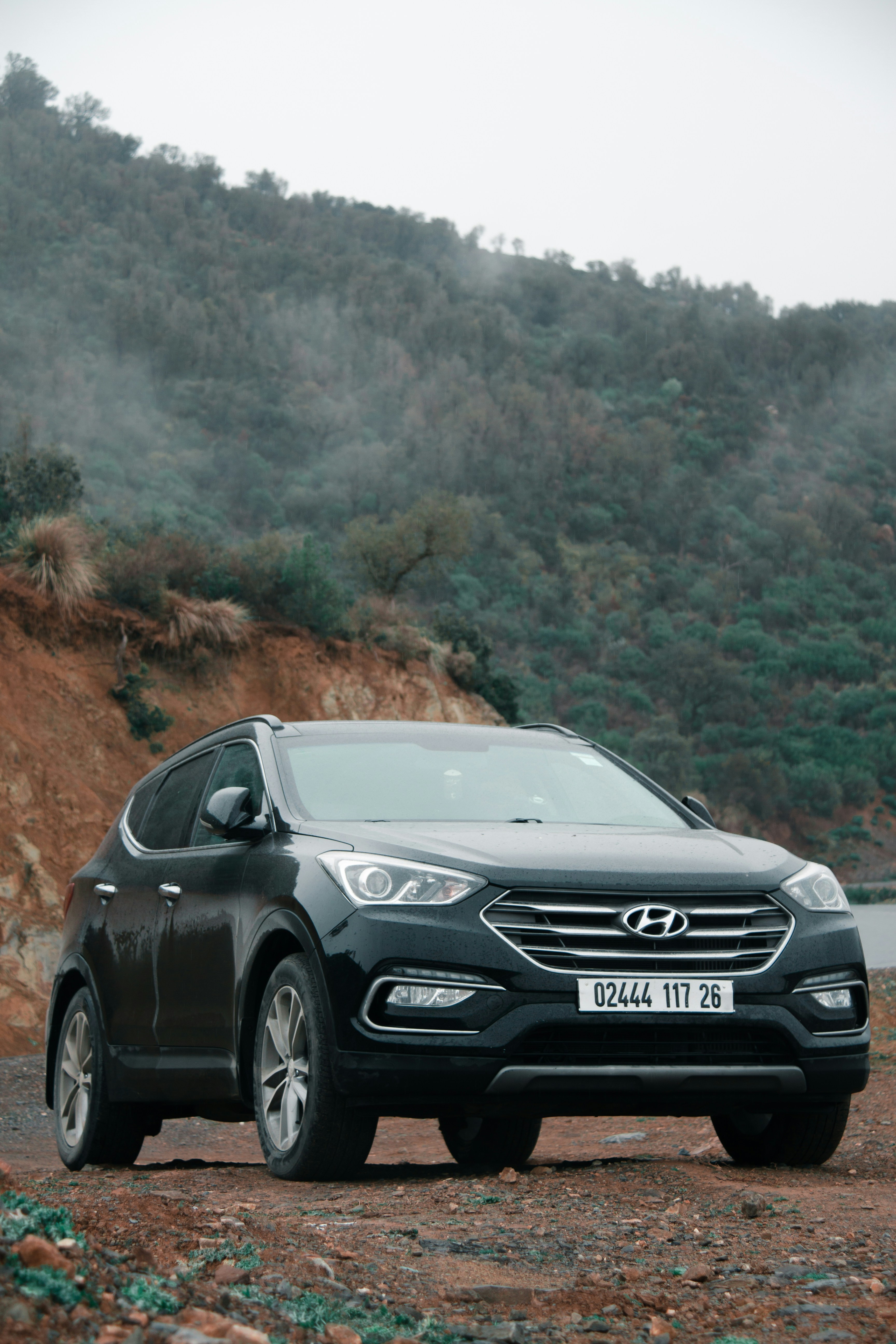 Front-Quarter View: Hyundai SUV Holds Ground on a Red-Dirt Ridge
