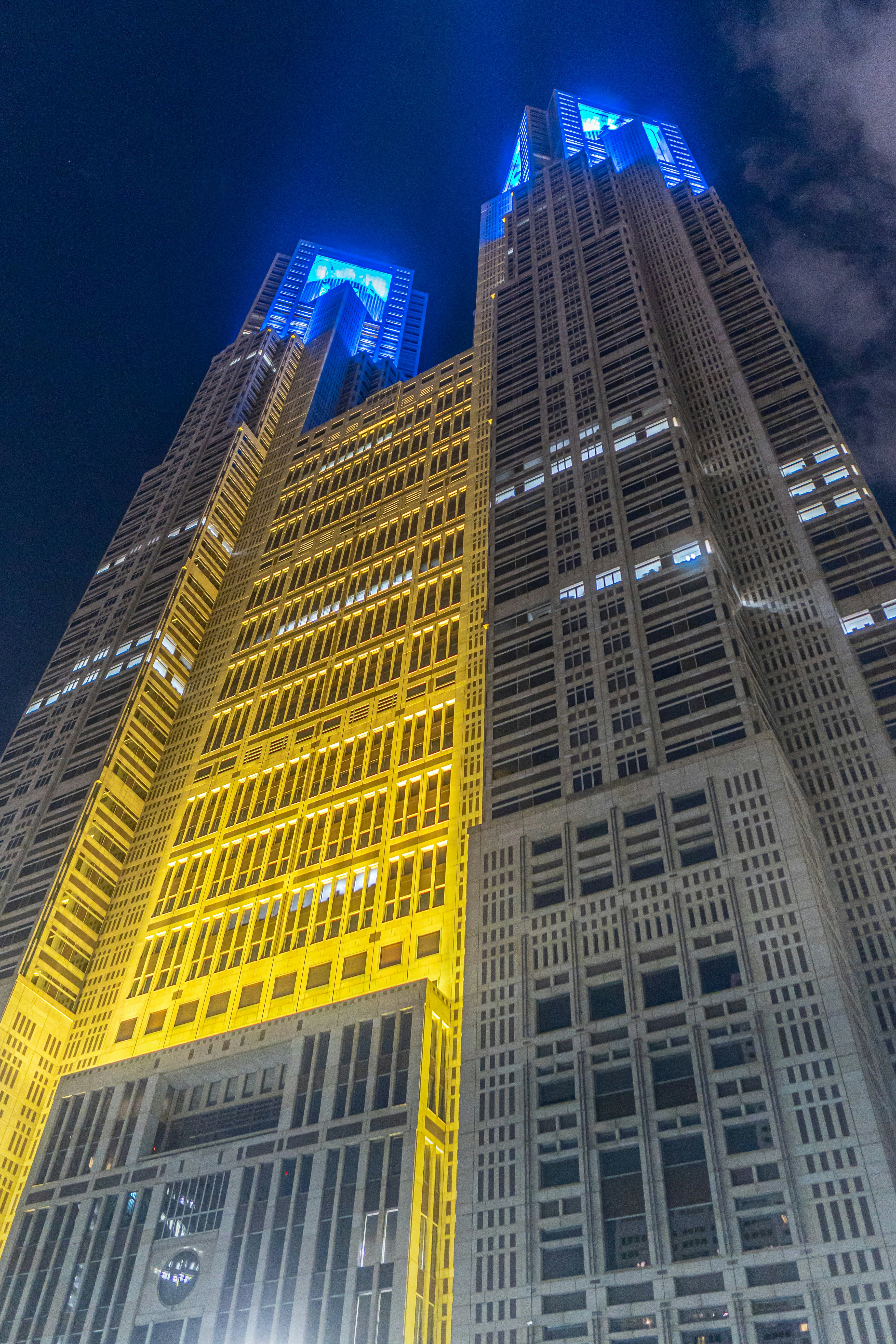 Blue-Crowned Towers: Night Geometry in Amber Light
