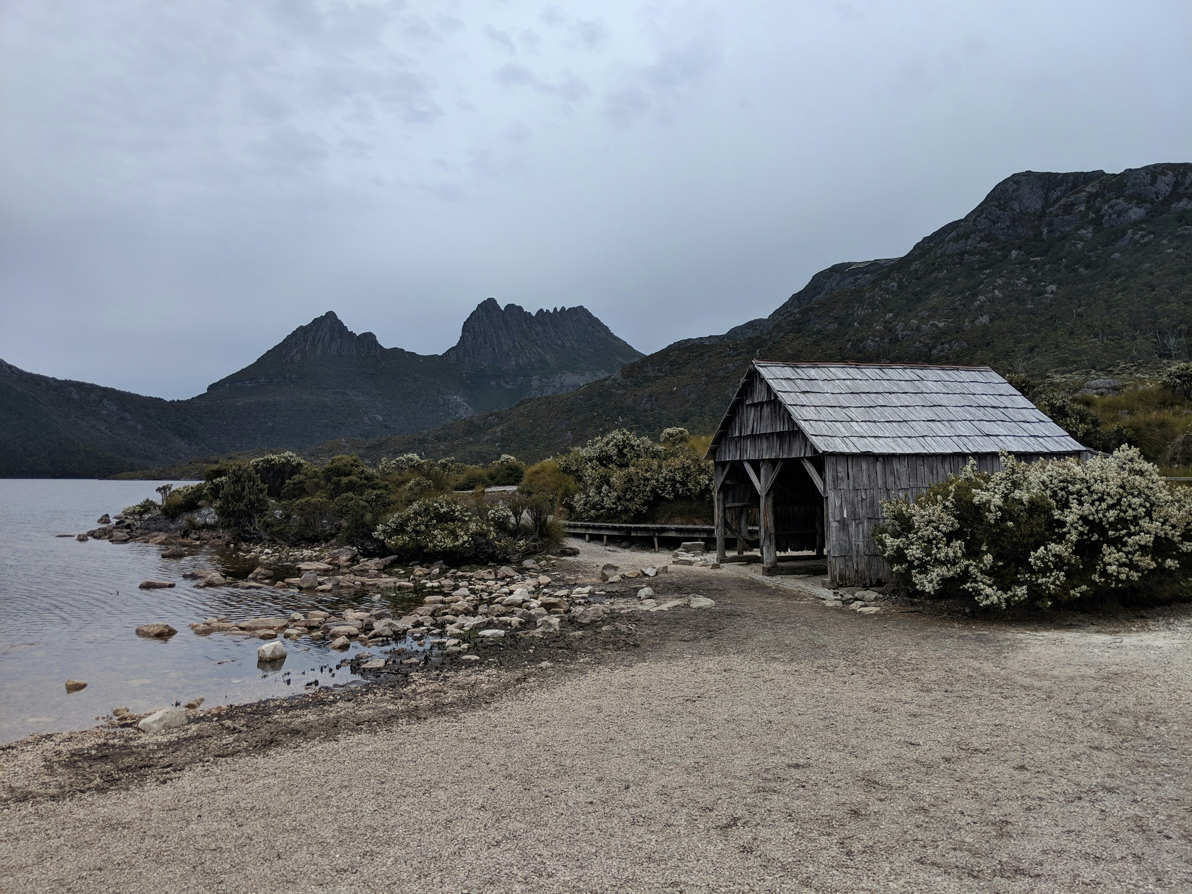 Rustic Lakeside Shack Framed by Rugged Peaks