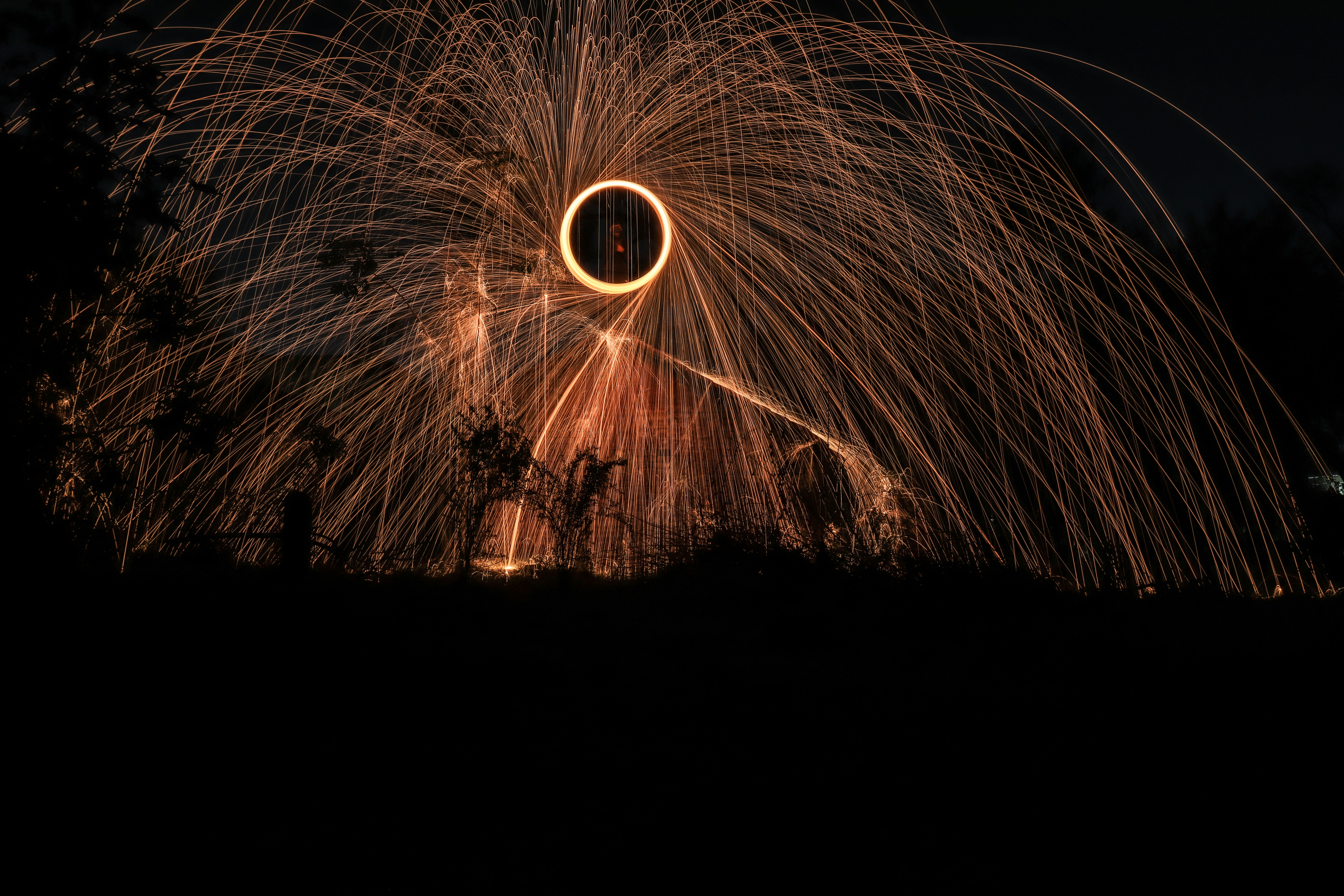 A firework is spinning in the night sky photo – Free Brown Image on ...