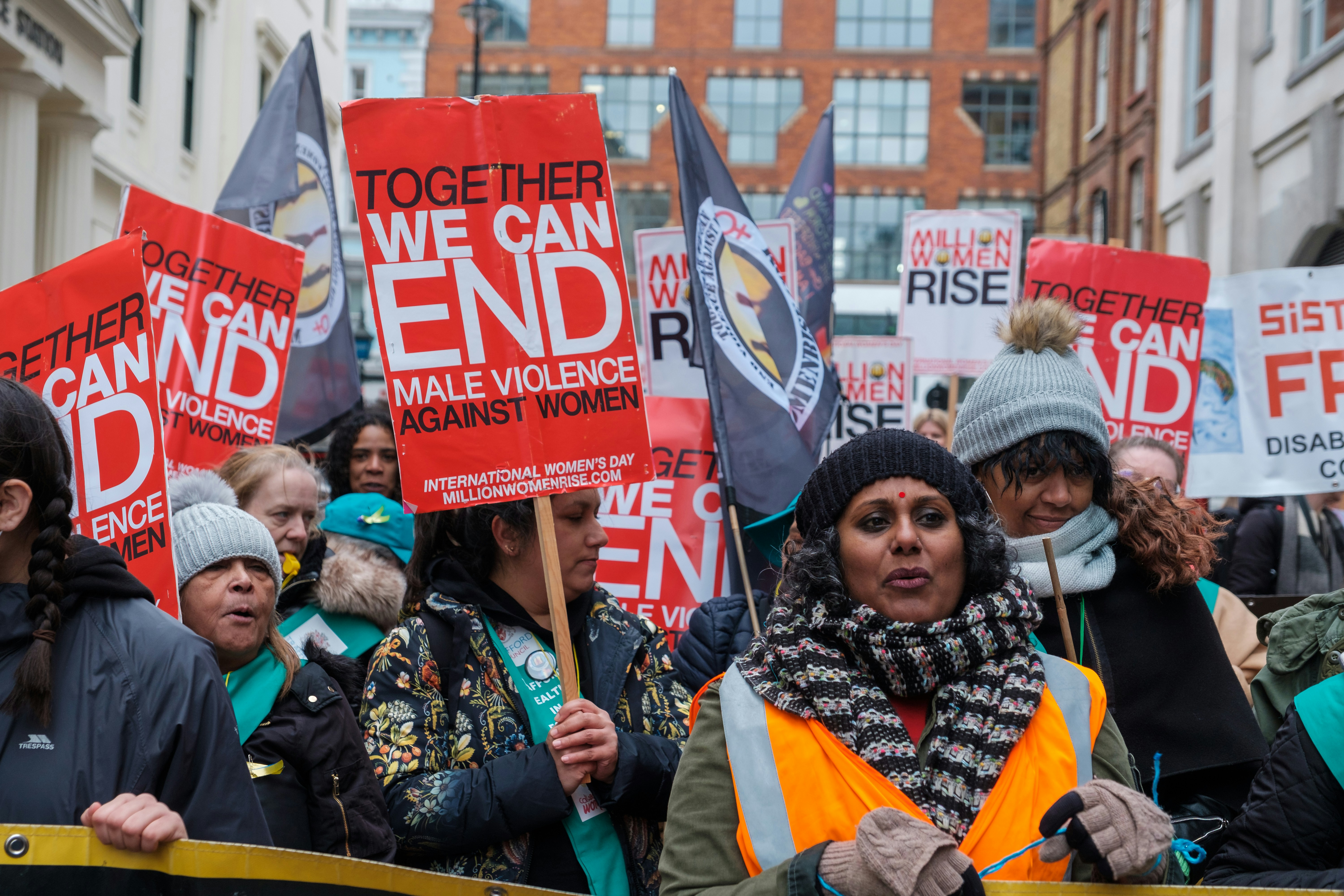 A group of people holding signs in the street photo – Free London Image ...