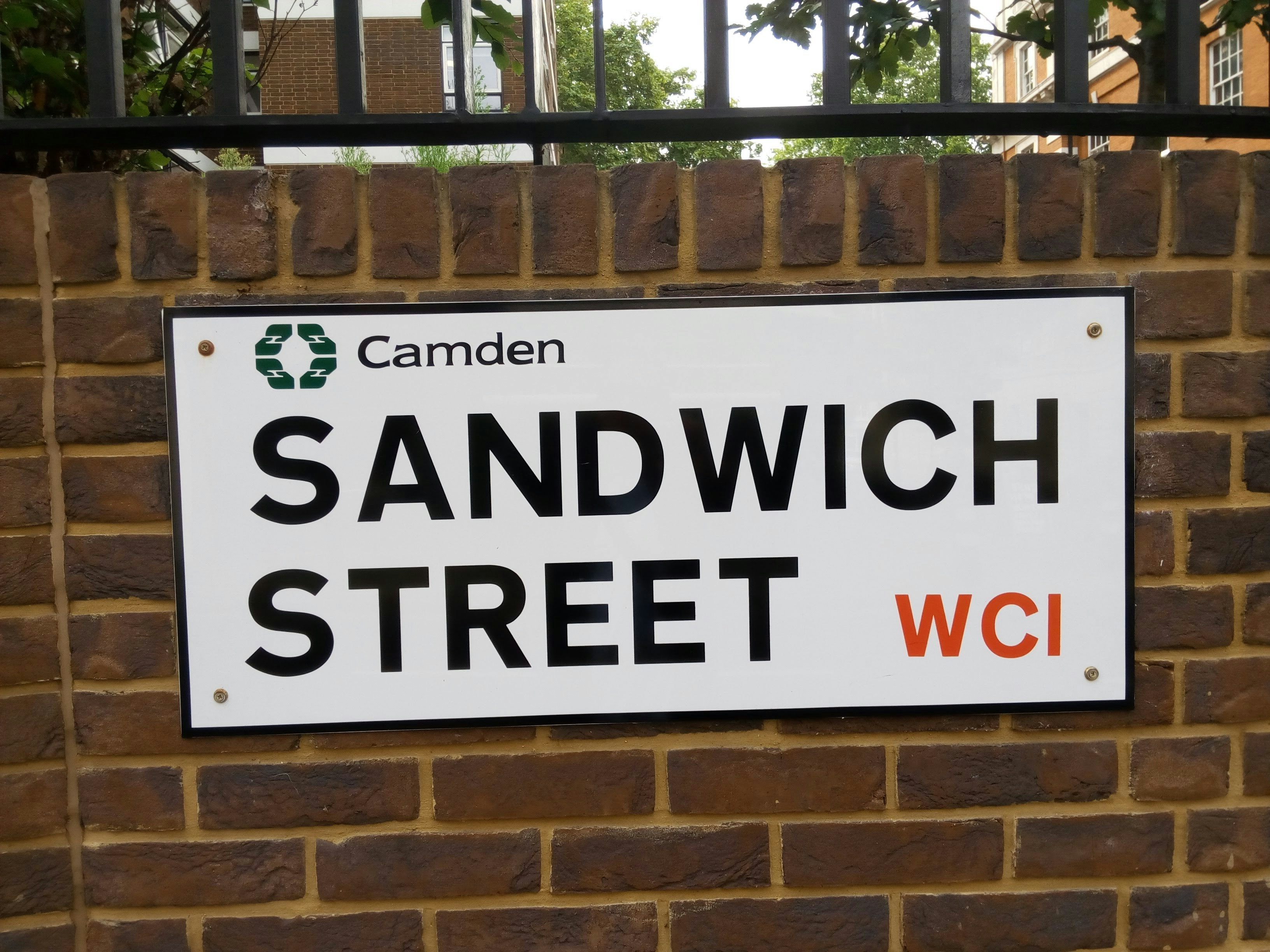 A sign on a brick wall that says sandwich street photo – Free London ...