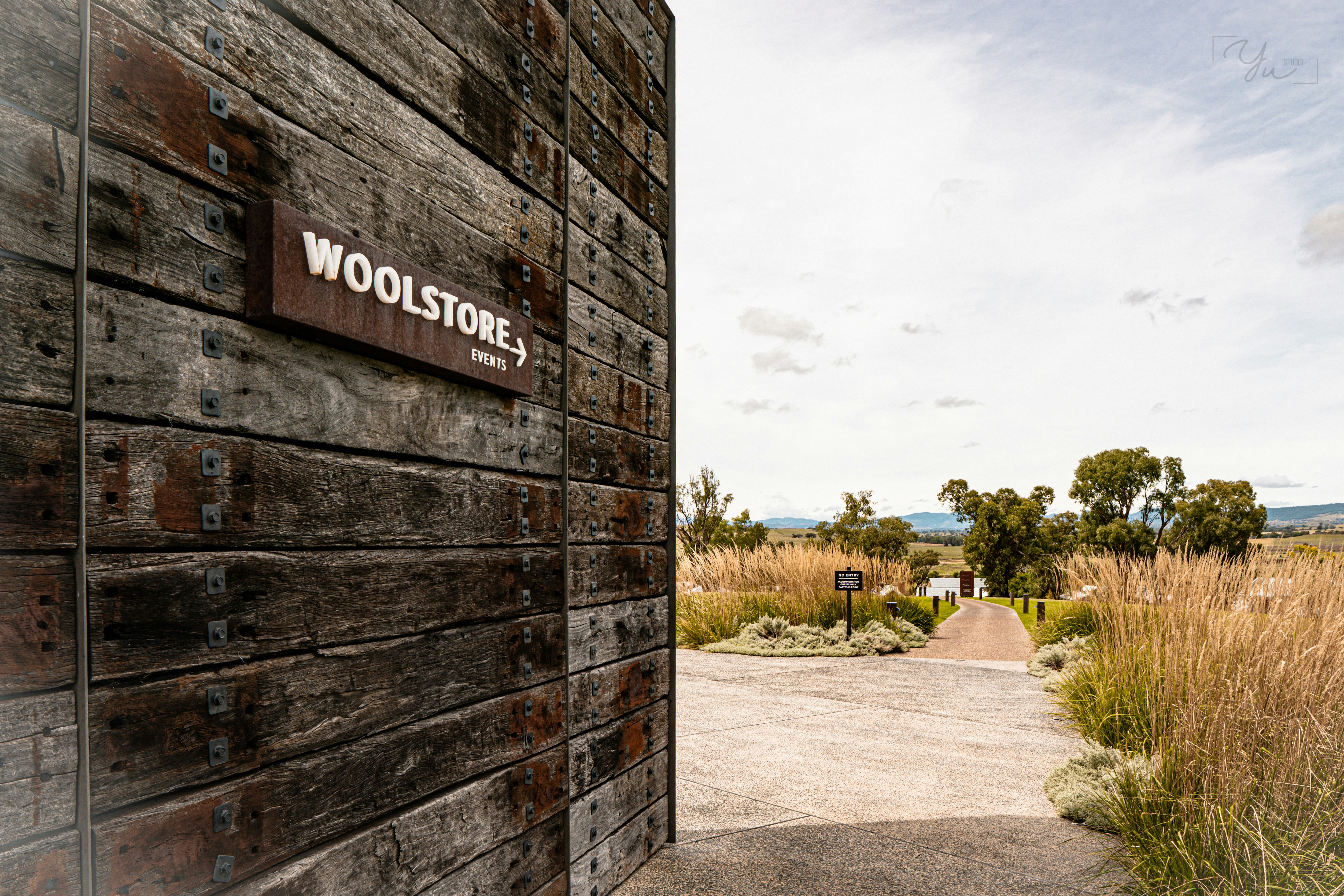 Woolstore Gateways: A Sunlit Path Through Rustic Timber