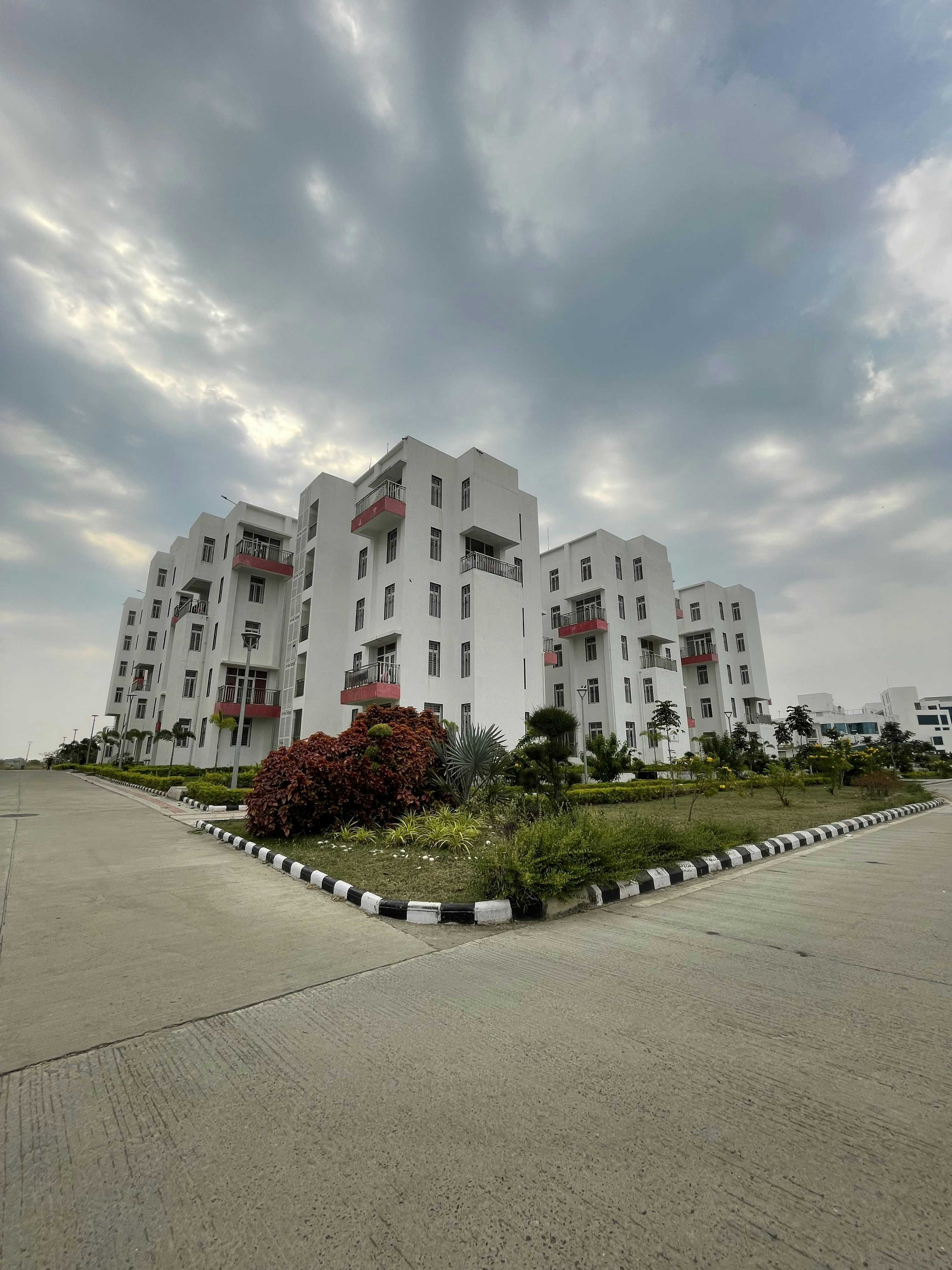 A large white building with red balconies on top of it photo – Free Iit ...