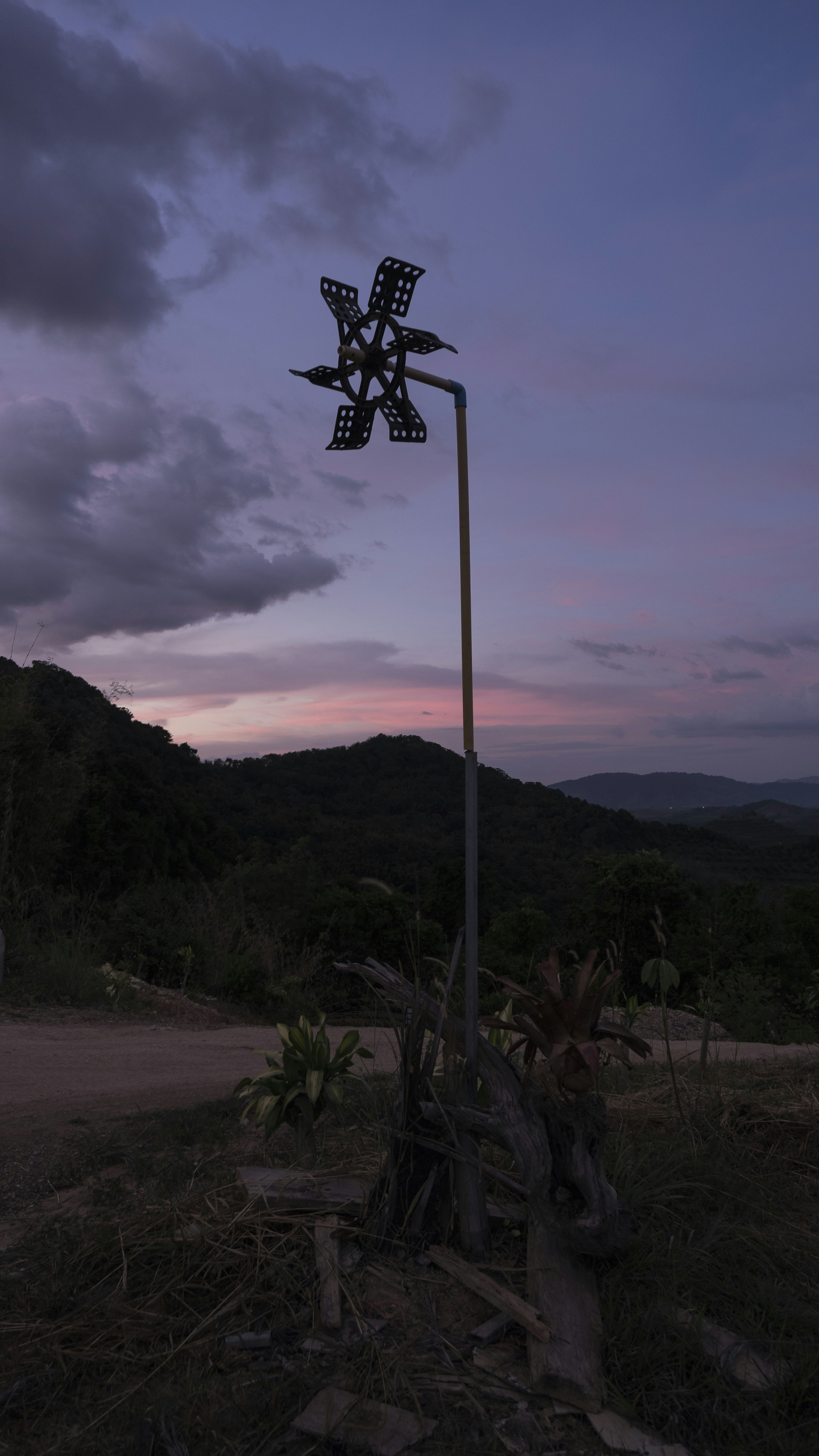 Silhouette of a Wind Sign Against a Dusk Horizon