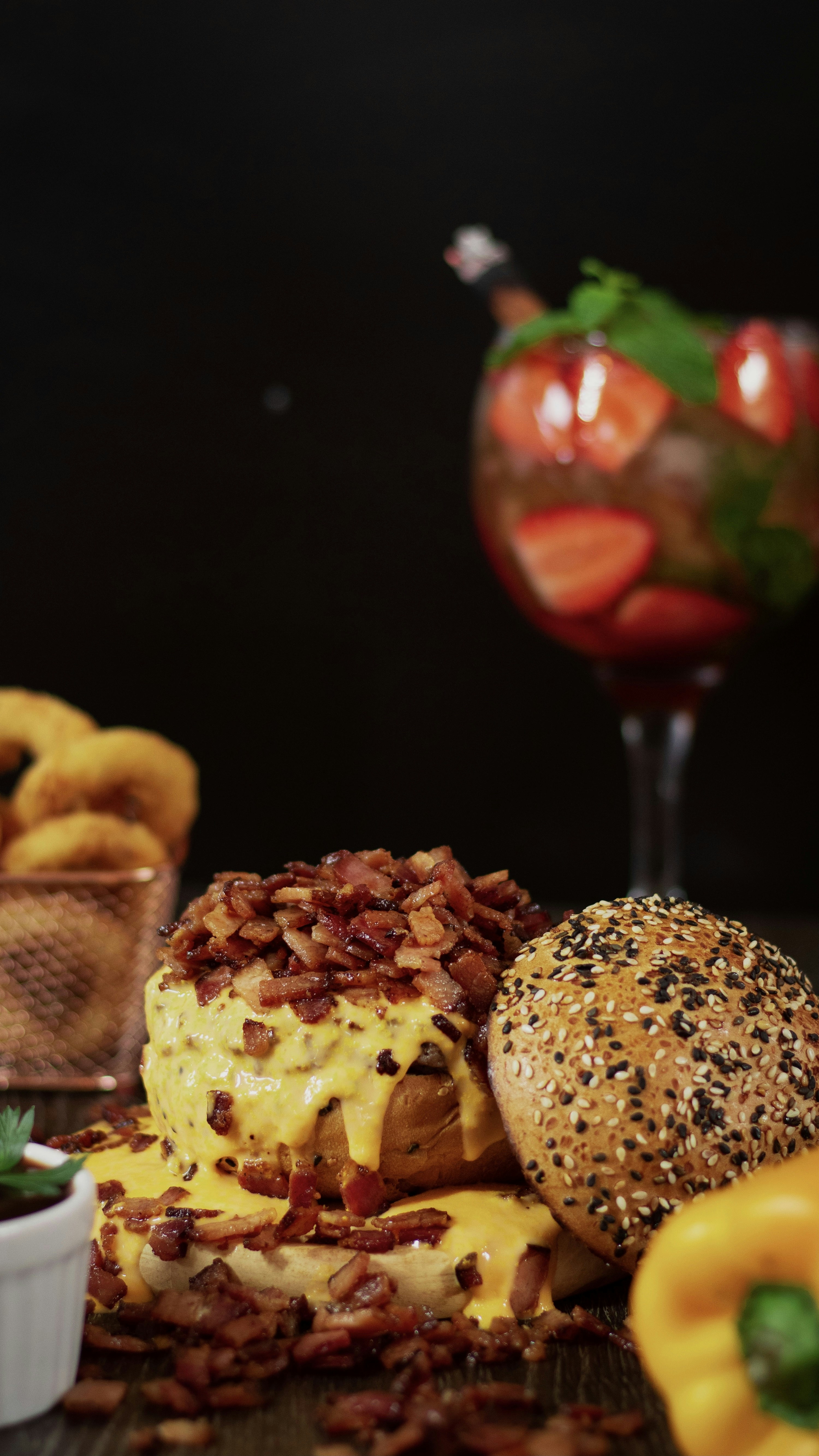 Bacon Crown Cheeseburger in Warm Glow with a Strawberry Cocktail Backdrop