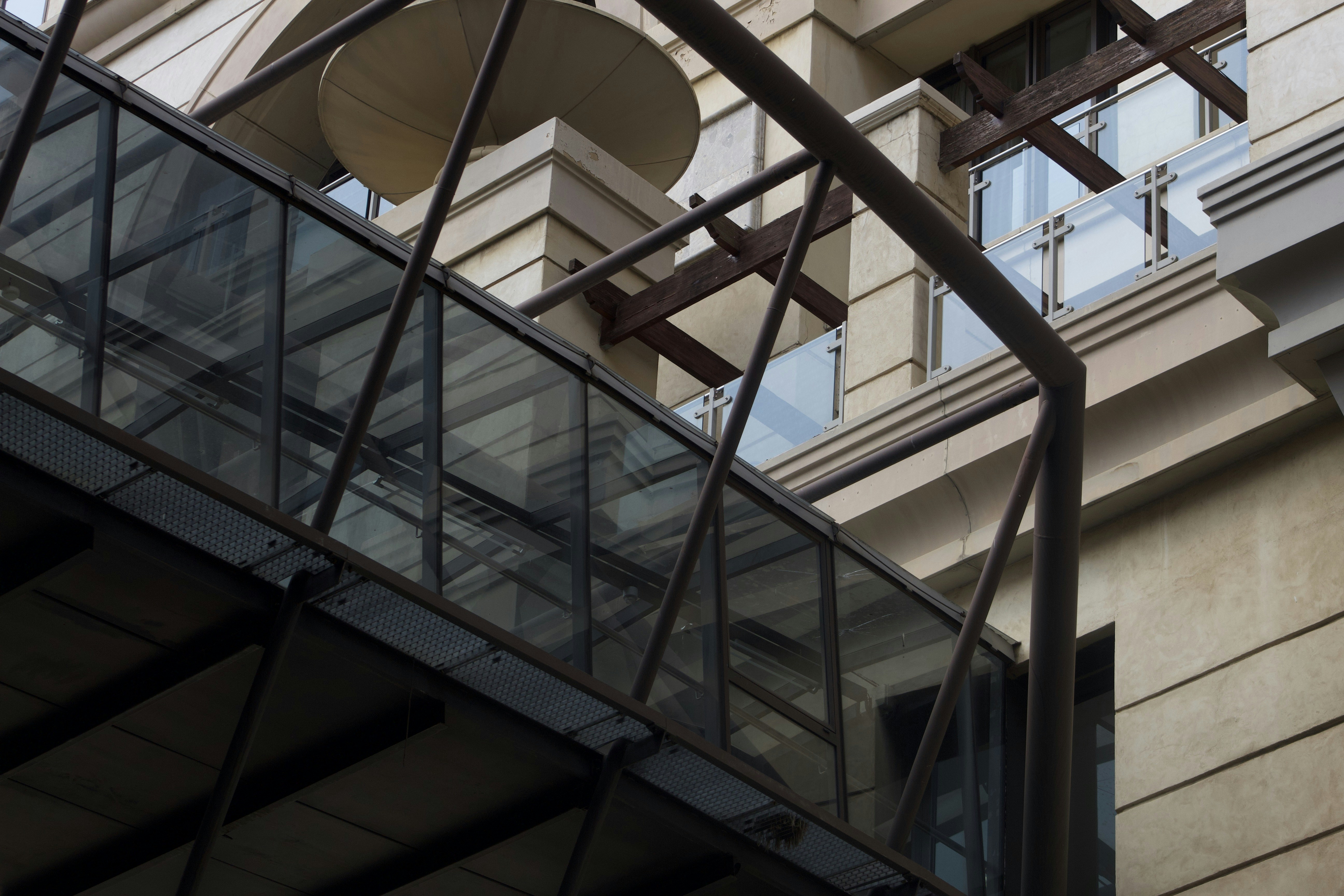 A building with a glass railing and a clock on it photo – Free Grey ...