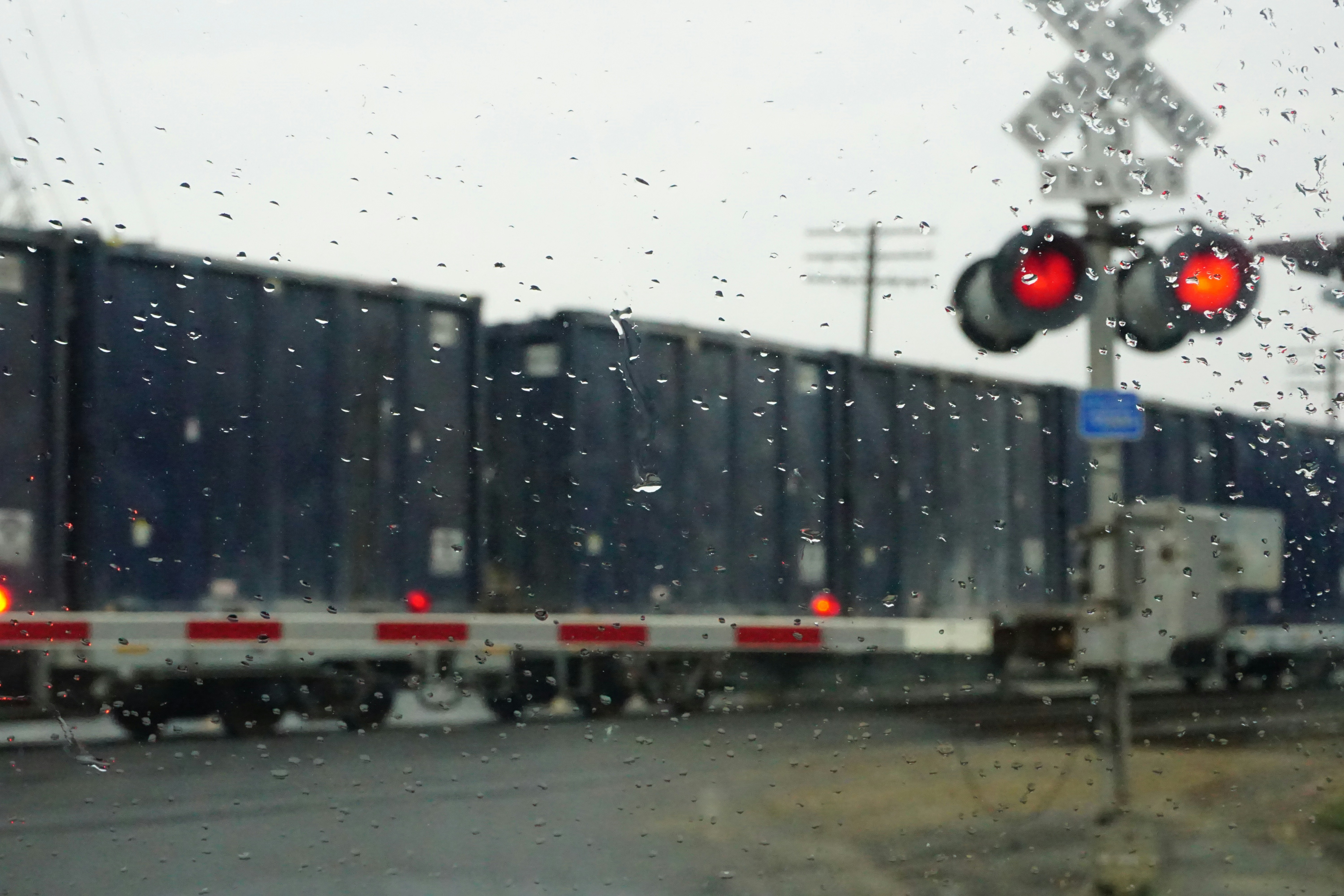 A train traveling down train tracks next to a traffic light photo ...
