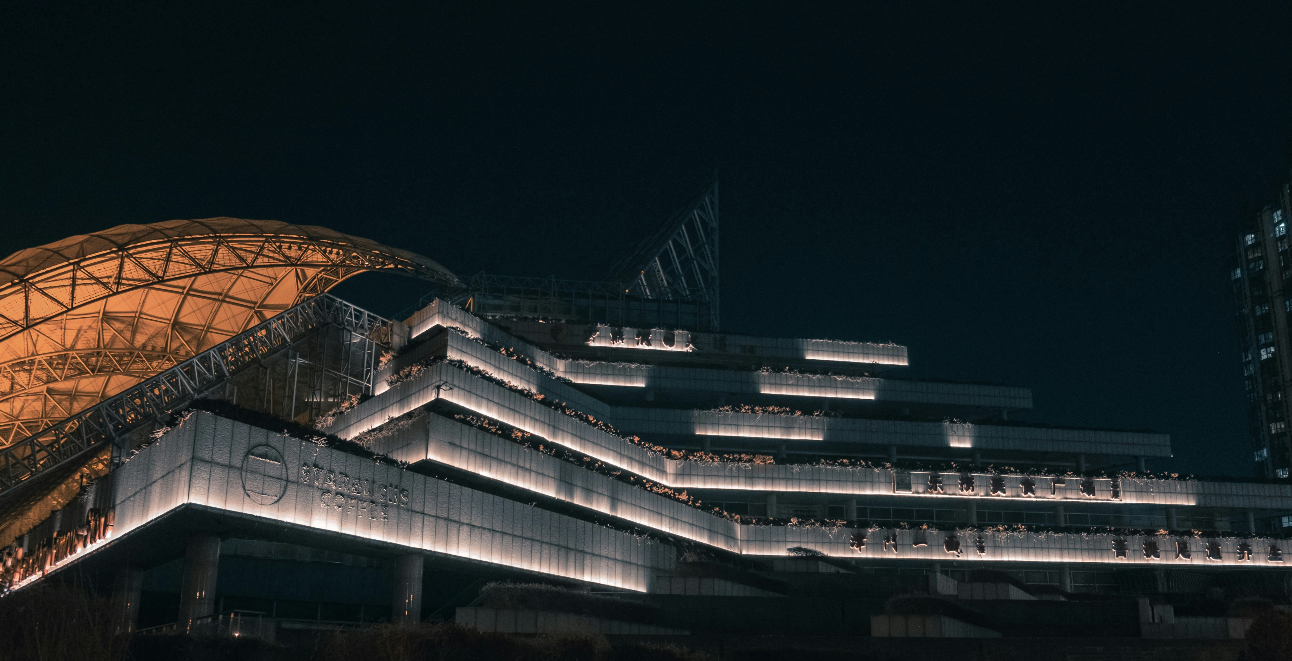 Luminous Tiered Facade Under Nightfall's Glass Dome