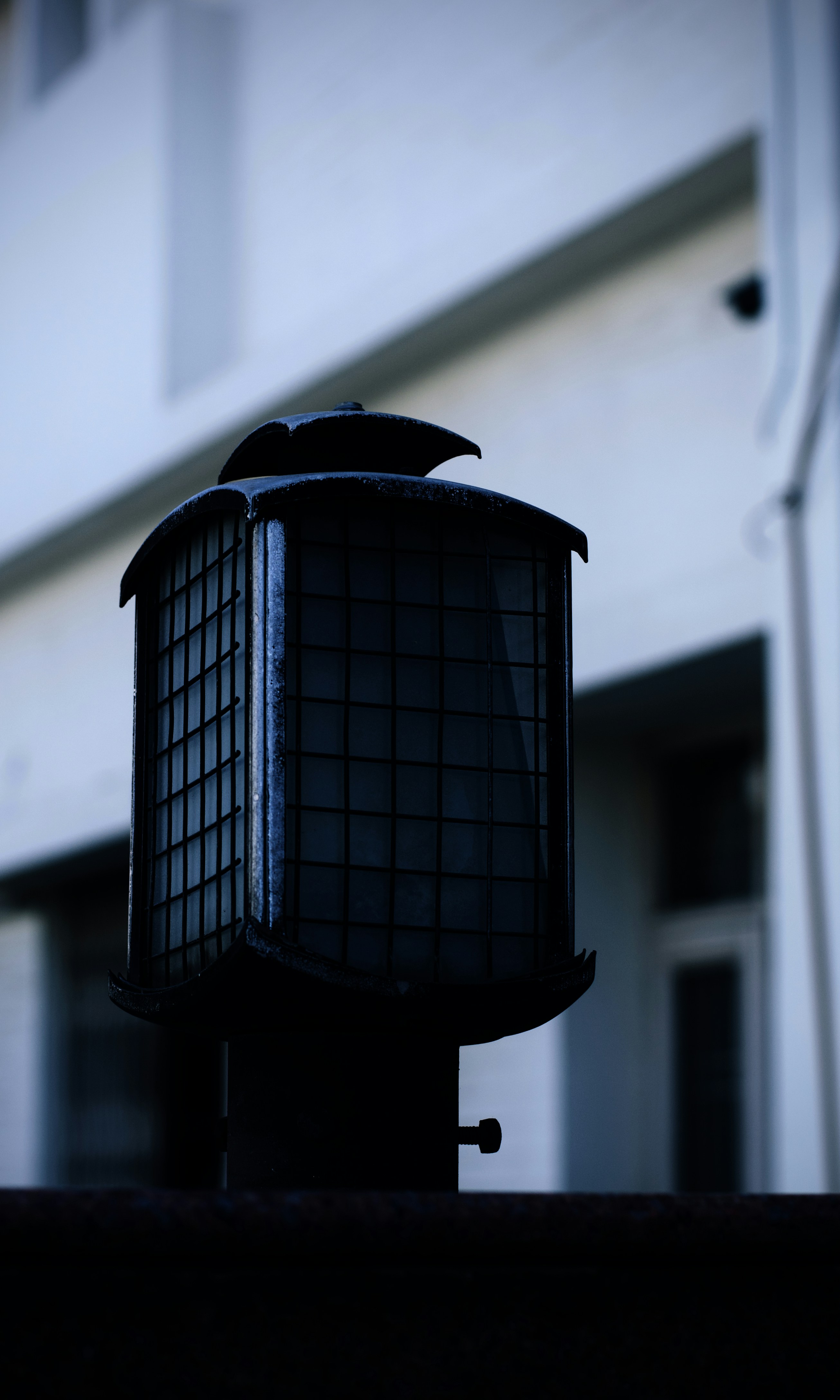 Dim Lantern against a Frosted Facade