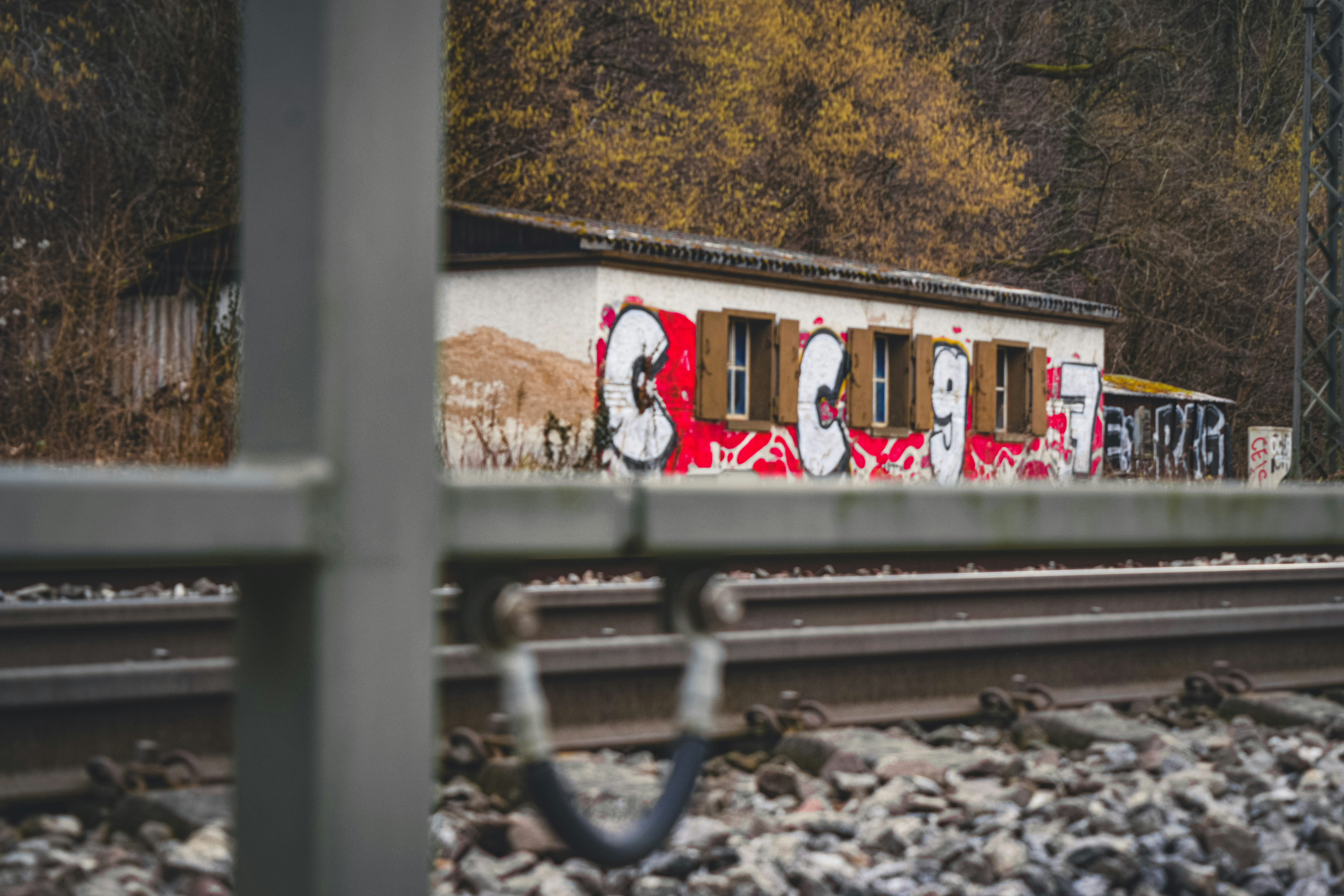 A red and white train car sitting on top of train tracks photo – Free ...