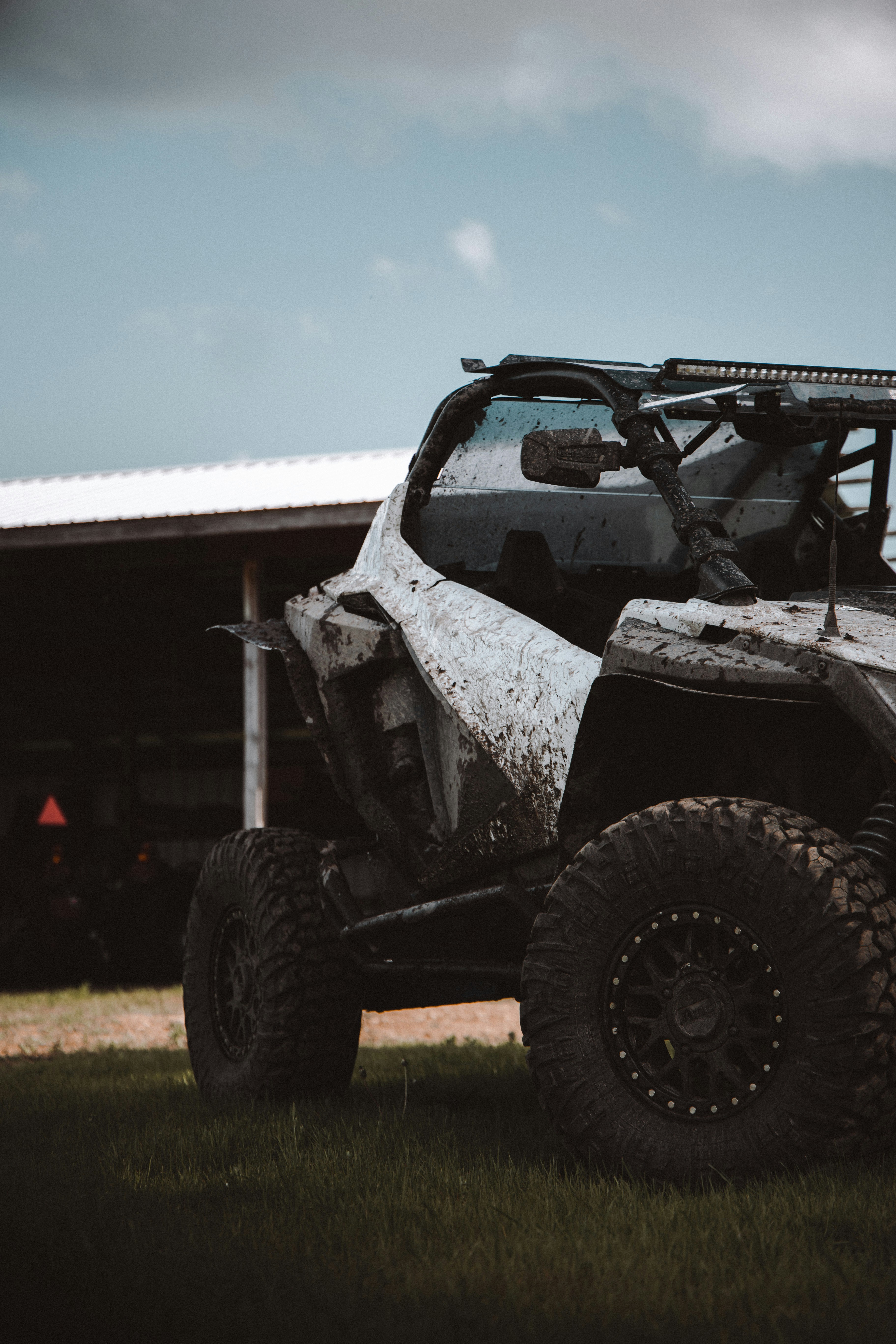 A can - am commander off - road vehicle parked in front of a building ...