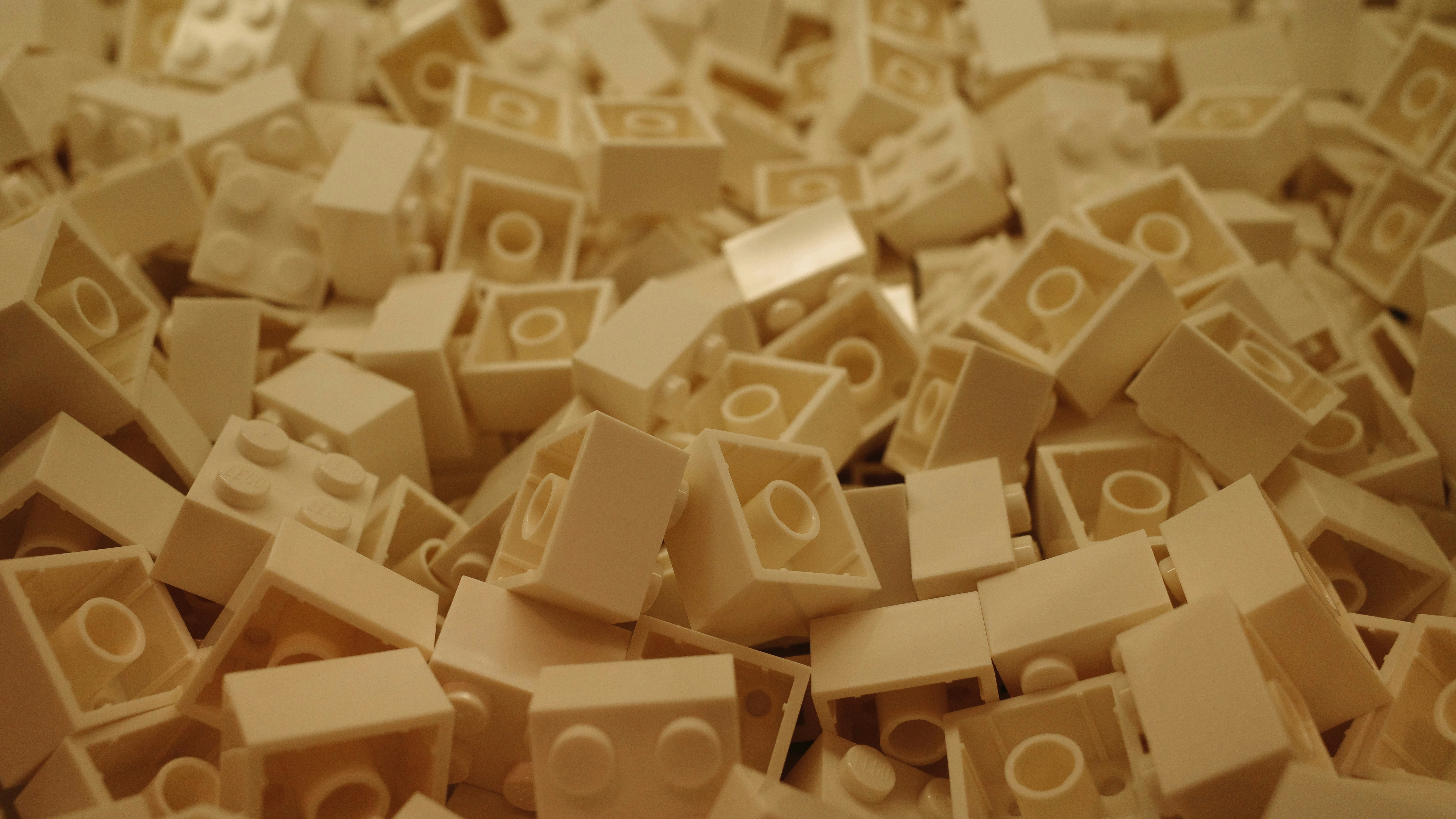 A pile of white lego blocks sitting on top of a table photo – Free Lego ...