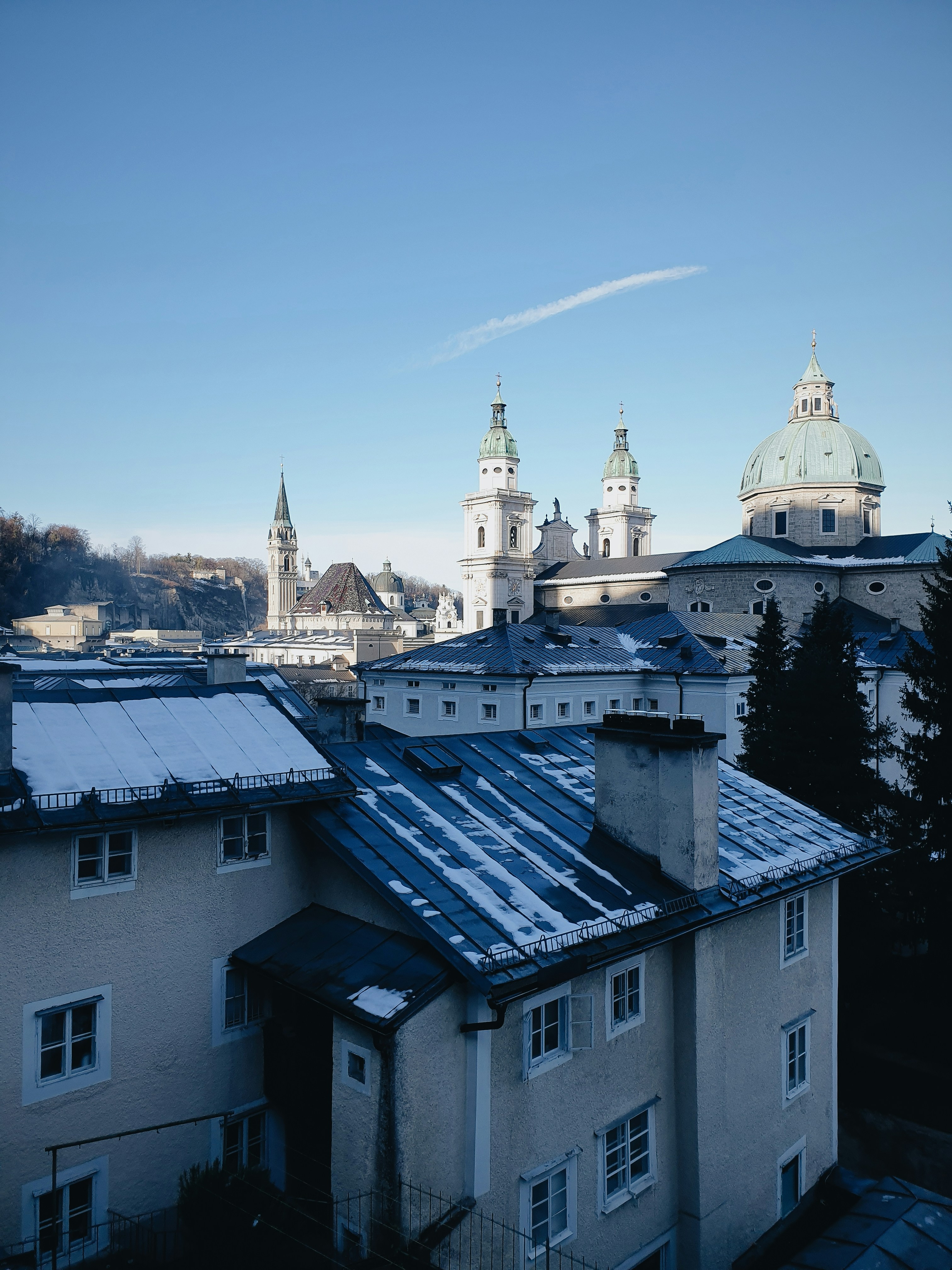 Green-Domed Cathedral Surges Above a Snowbound Rooftop Skyline