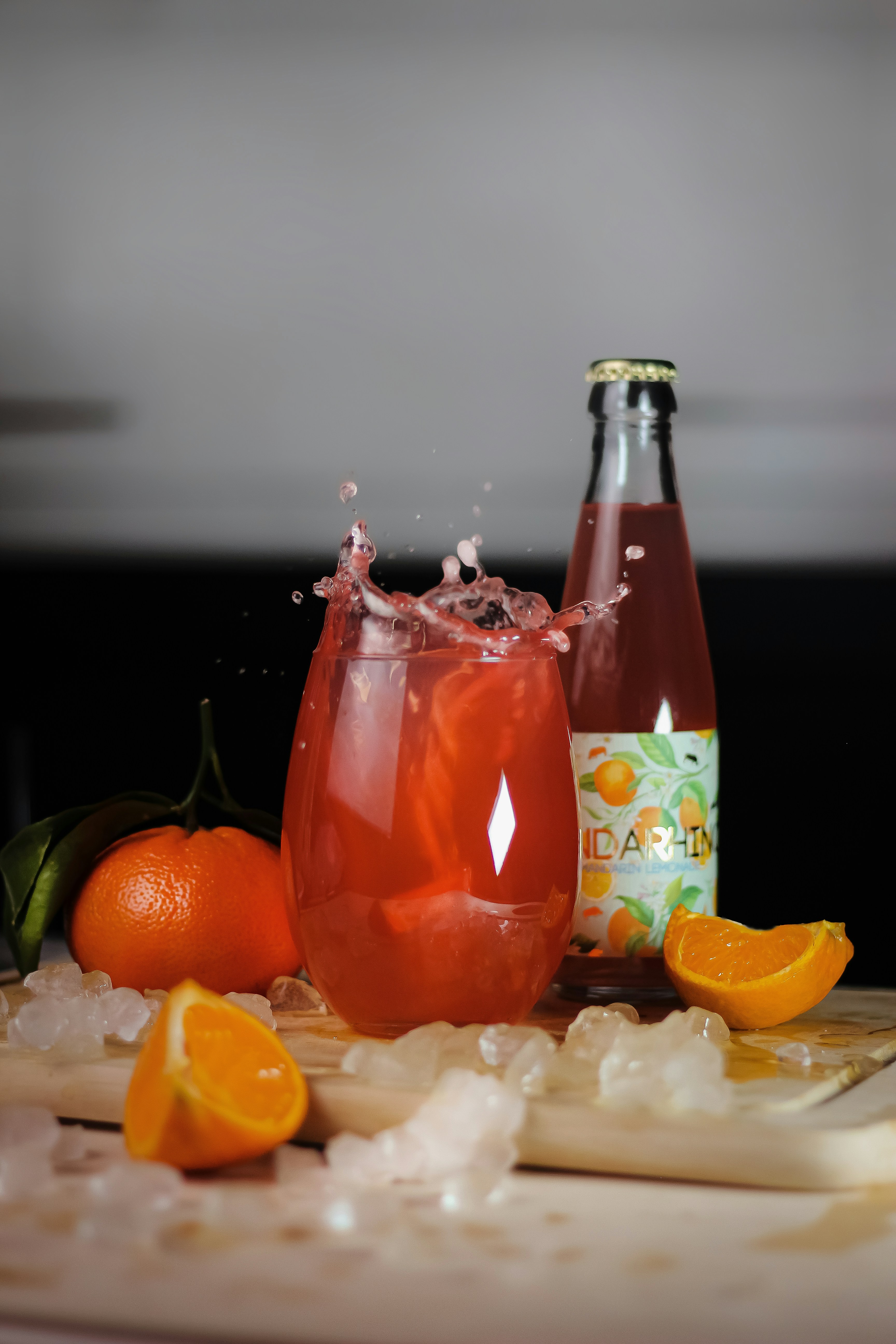 Citrus Splash: A Glass of Sunset Red with Orange Halos