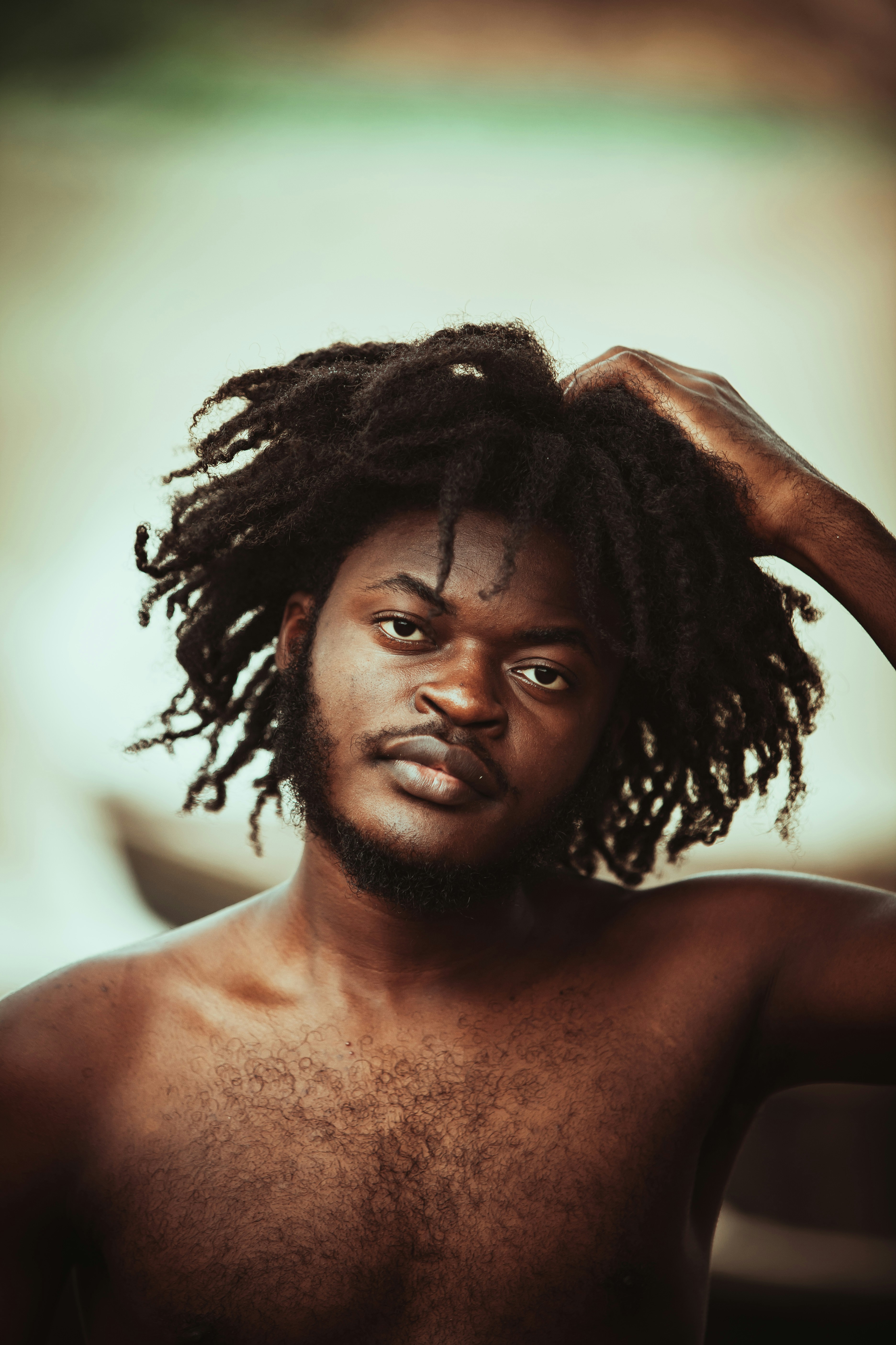 A man with dreadlocks is posing for a picture photo – Free Documentary ...