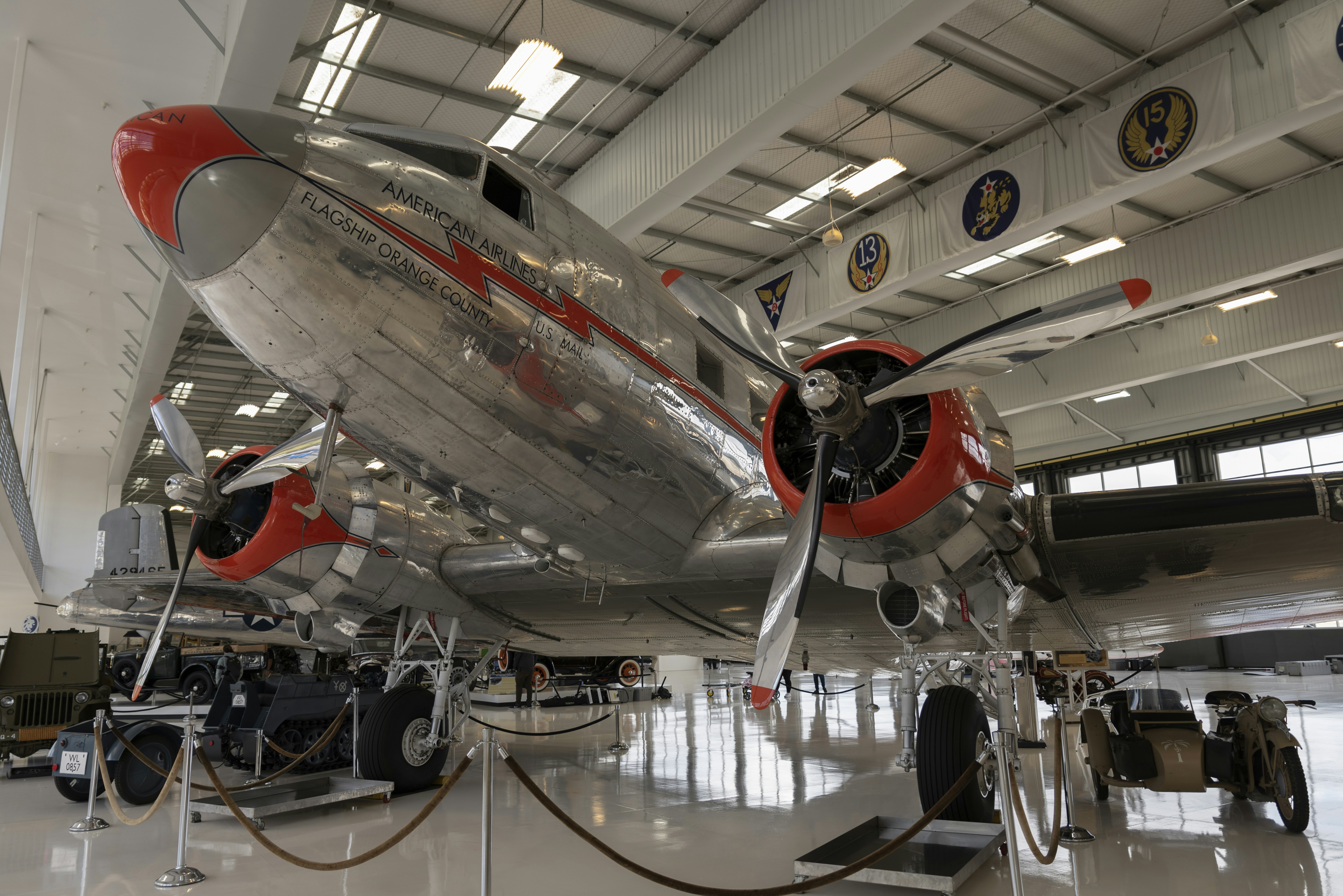 A red and silver airplane is on display in a hangar photo – Free Ww2 ...