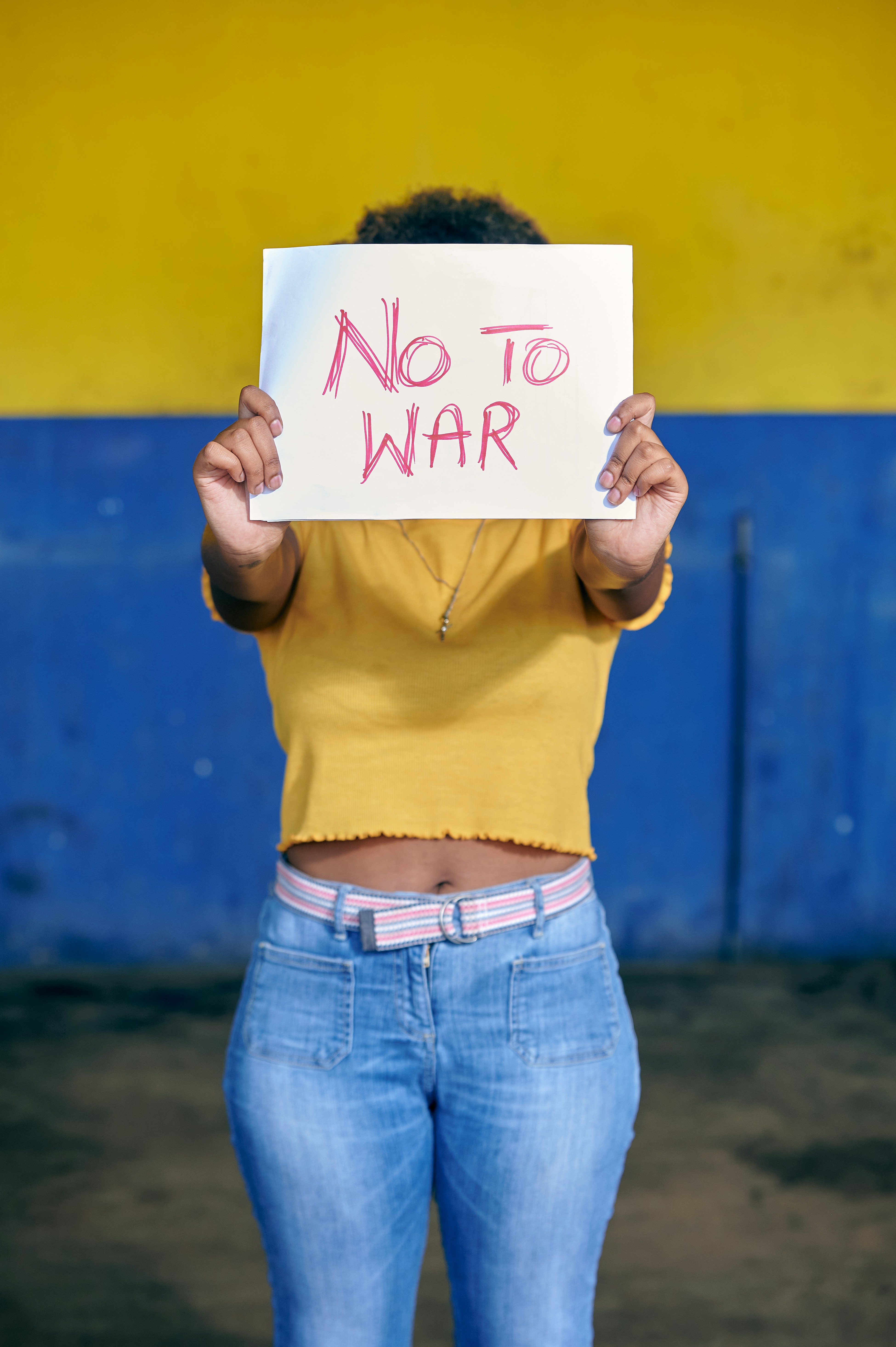 No to War: A Direct Sign Against a Yellow-Blue Backdrop