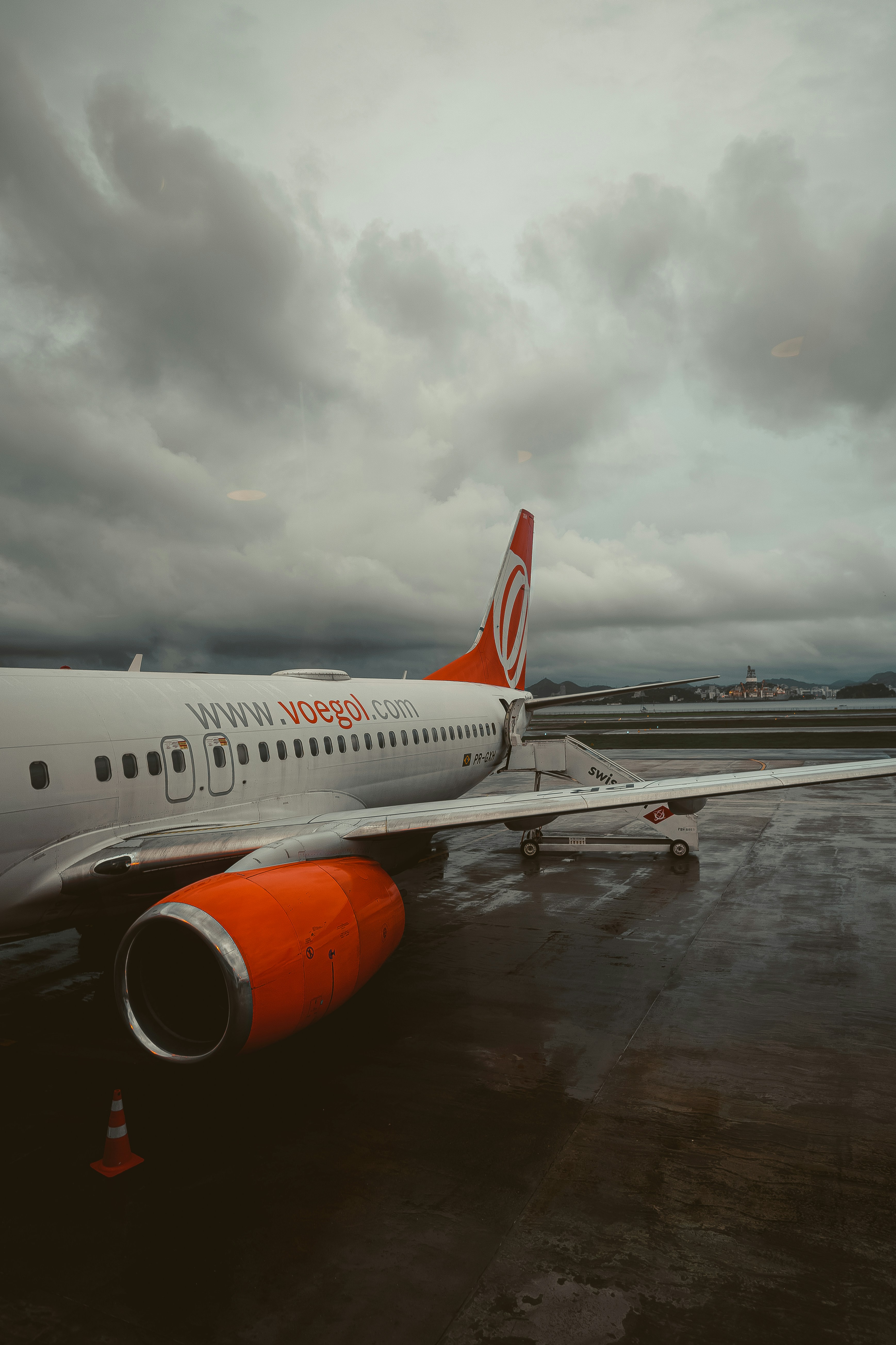 Orange Engine, Grey Sky: A Ground-Level View of a Nordic Jet at the Gate