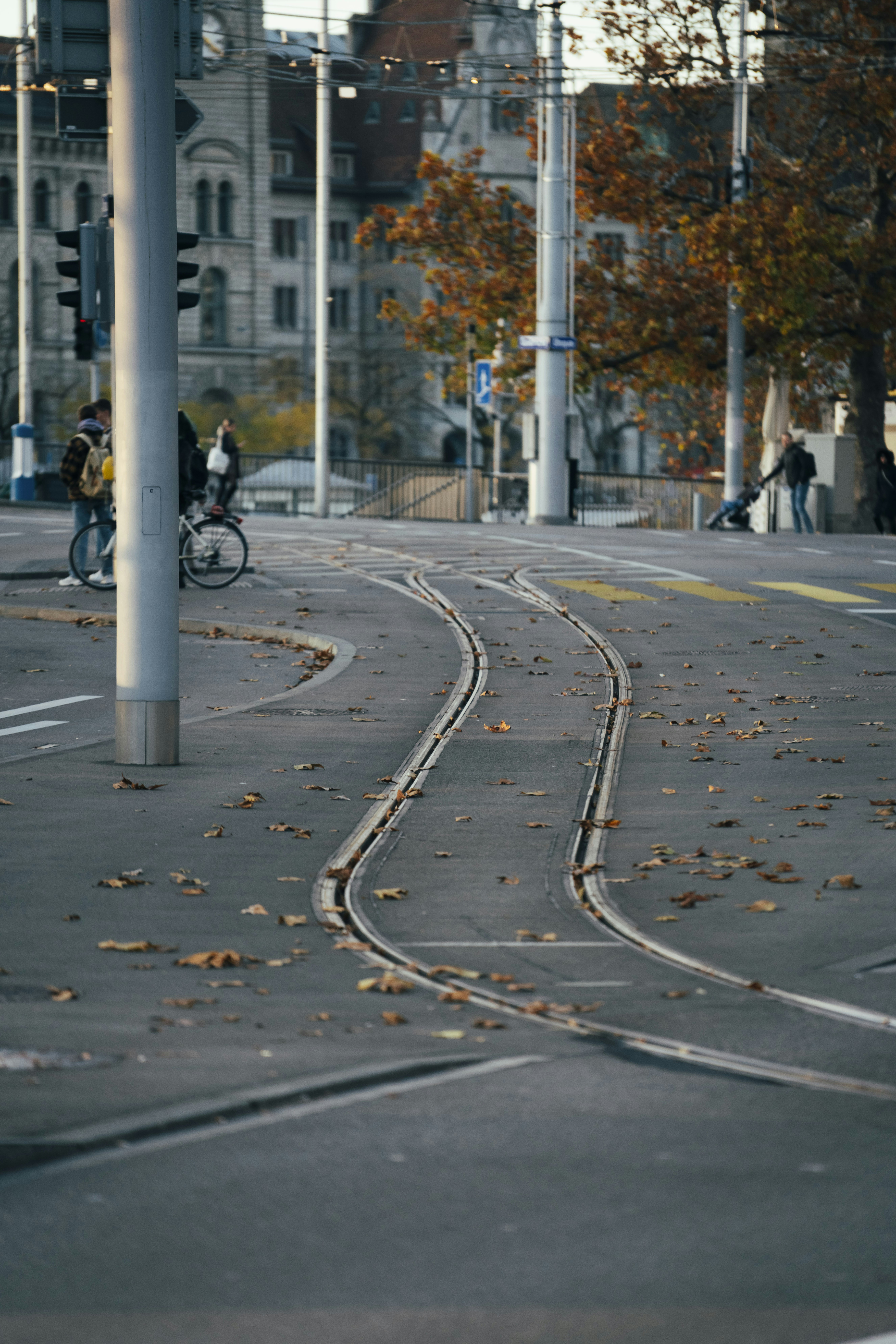 a couple of people riding bikes down a street
