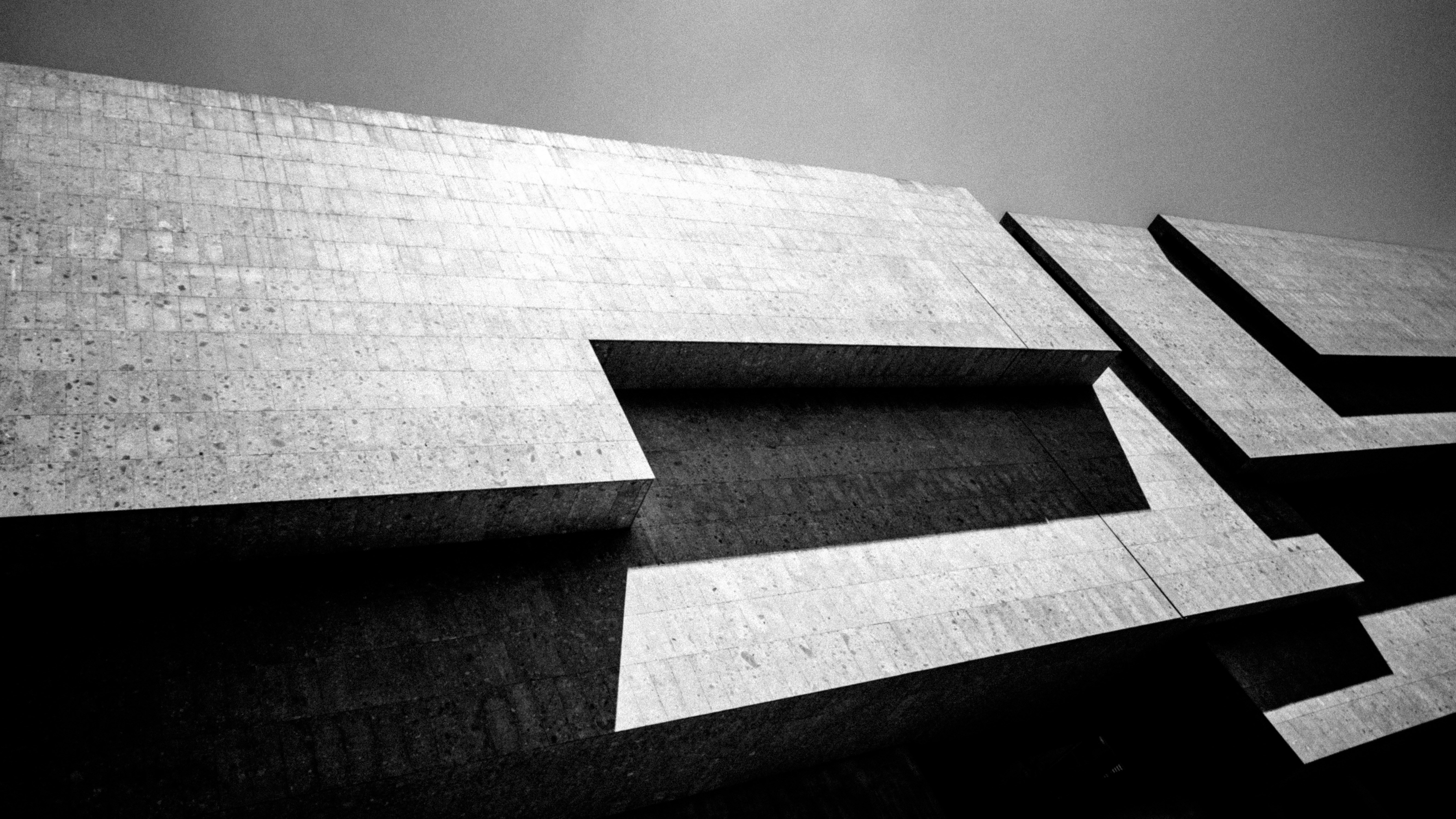 Monochrome Angles: Interlocking Concrete Planes in Quiet Geometry