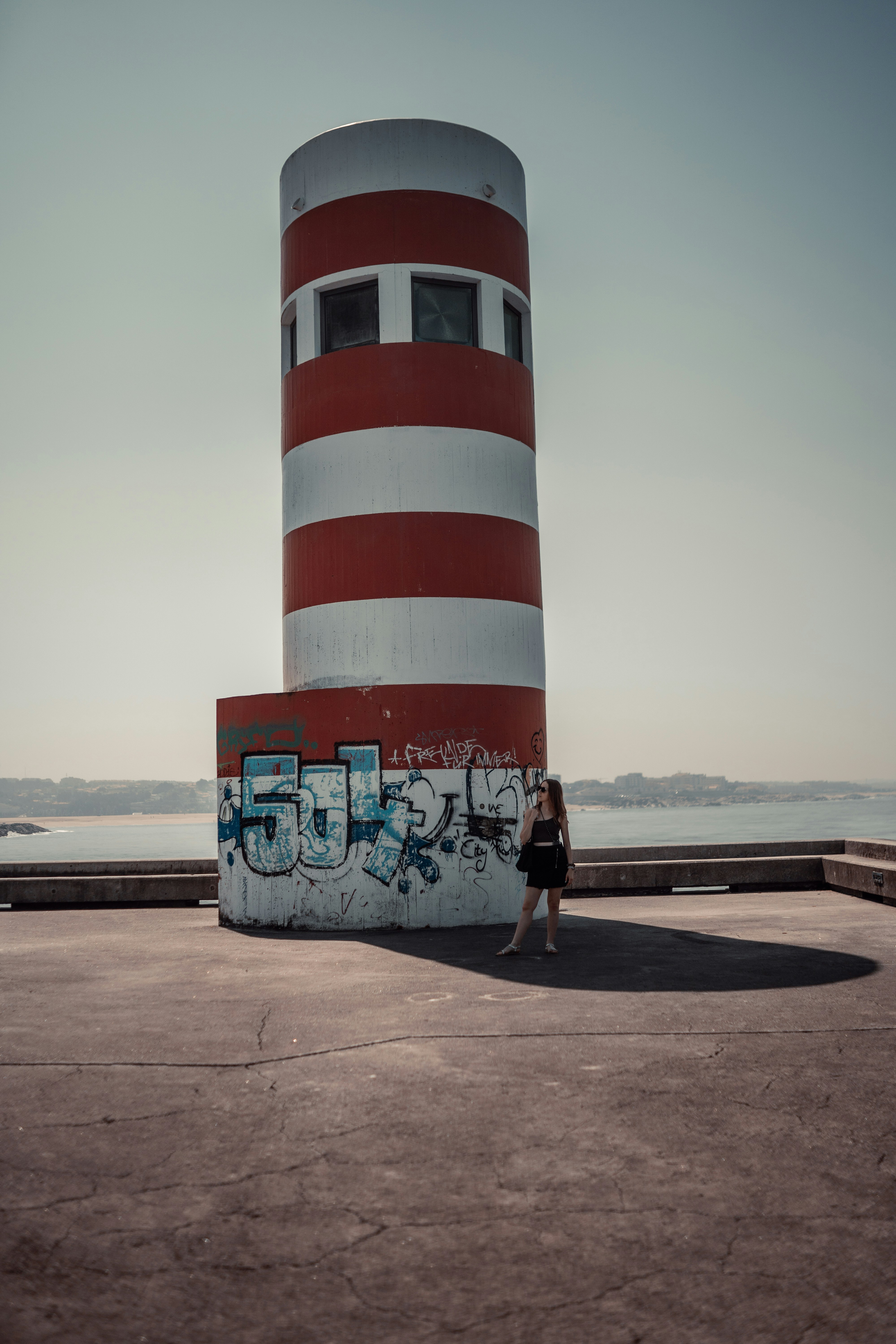 Red and White Beacon: A solitary lighthouse watching over the pier