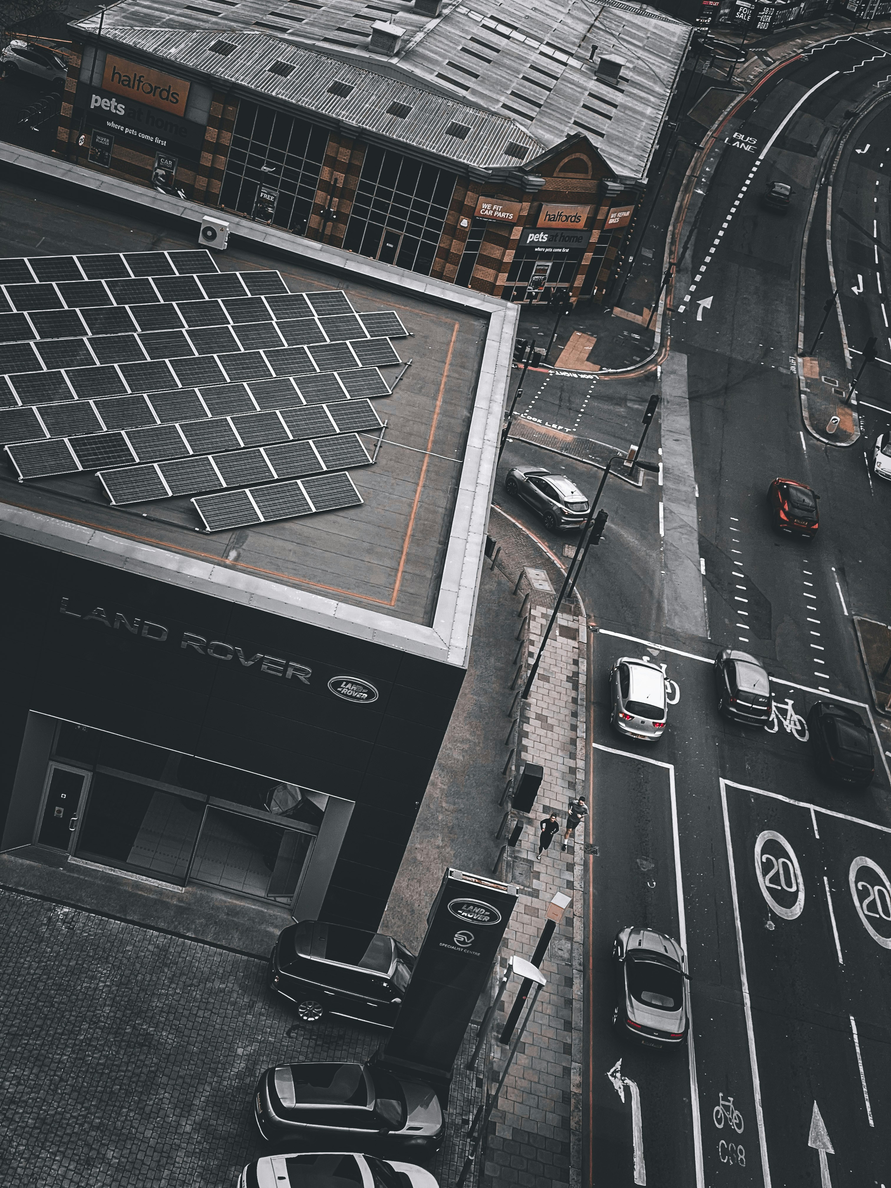 Urban Rooftop Perspective: Solar Tiles and Traffic Veins