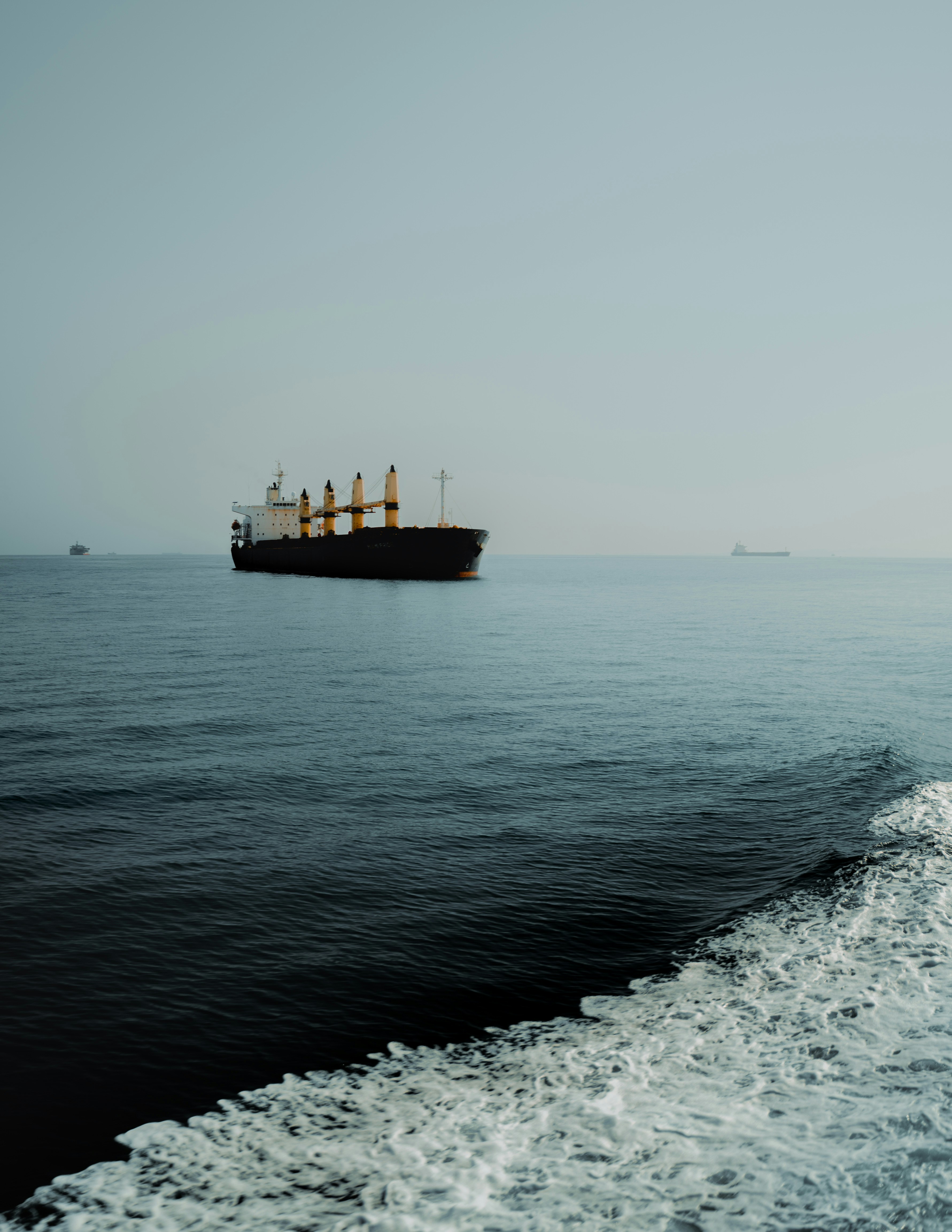 A large ship sailing across a large body of water photo – Free ...