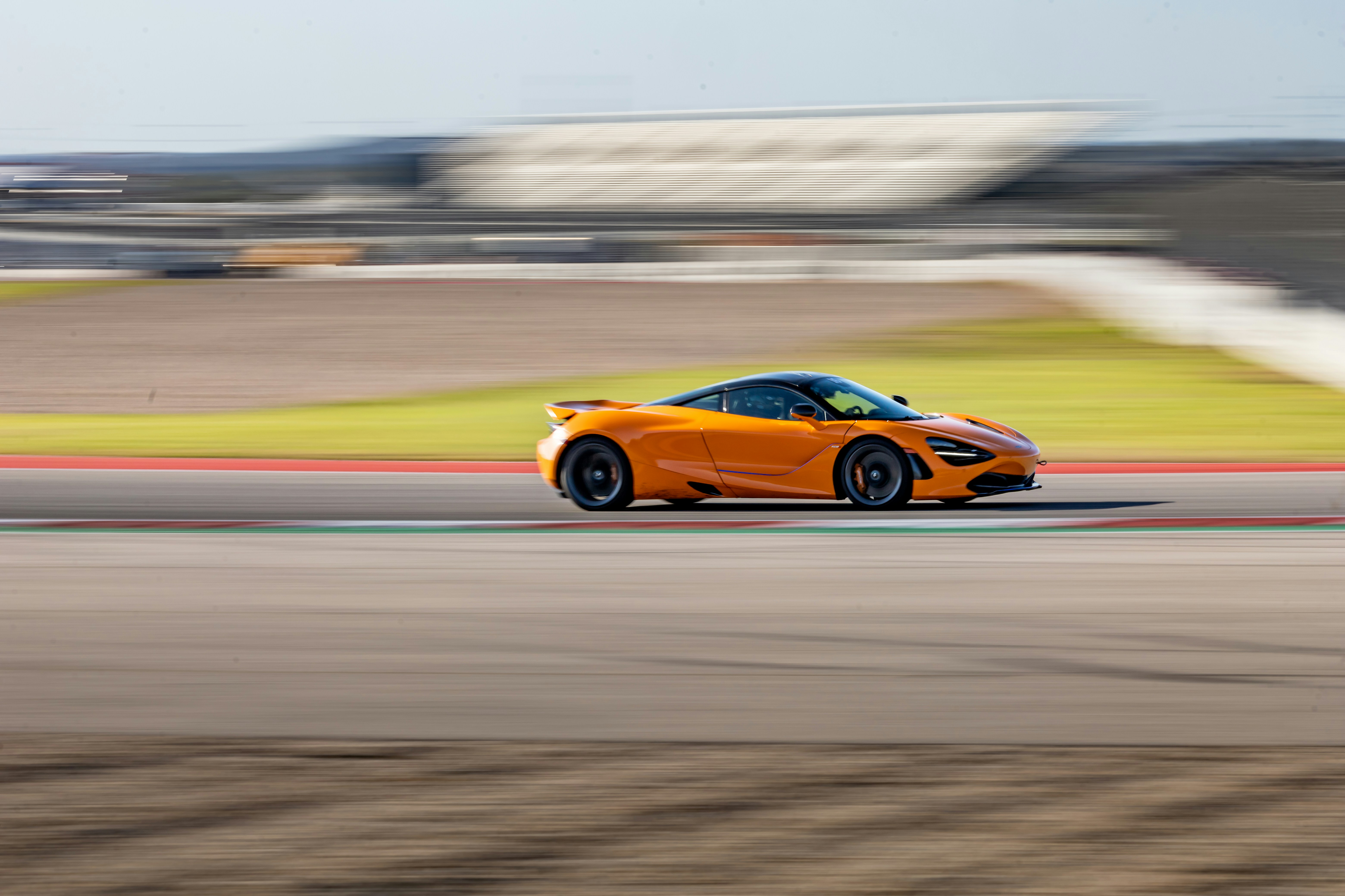 An orange sports car driving on a race track photo – Free Automobile ...