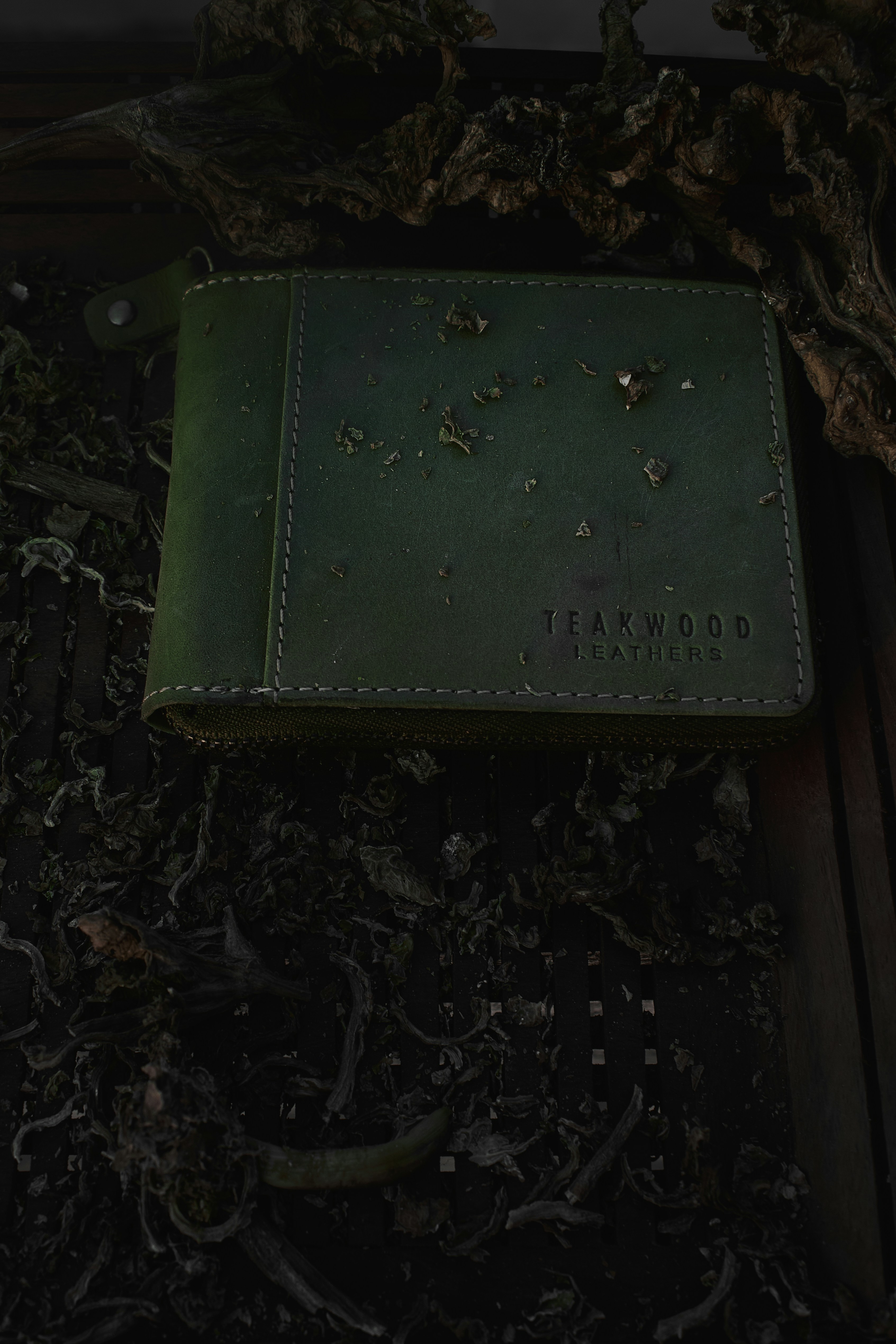 Teakwood Leather Wallet Quietly Nestled in a Bed of Dried Foliage