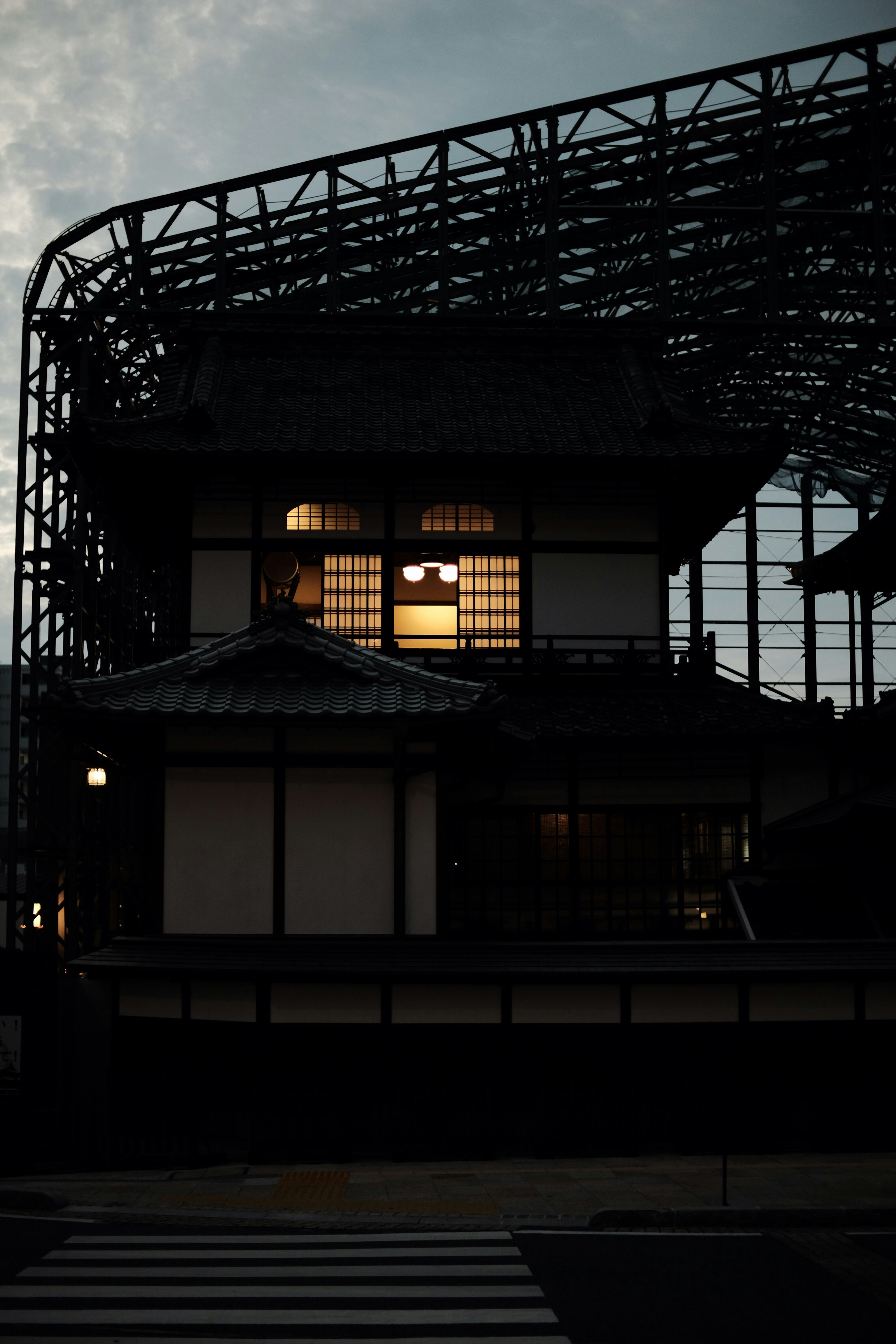 Dusk Light Through a Traditional Japanese House Framed by a Steel Skeleton