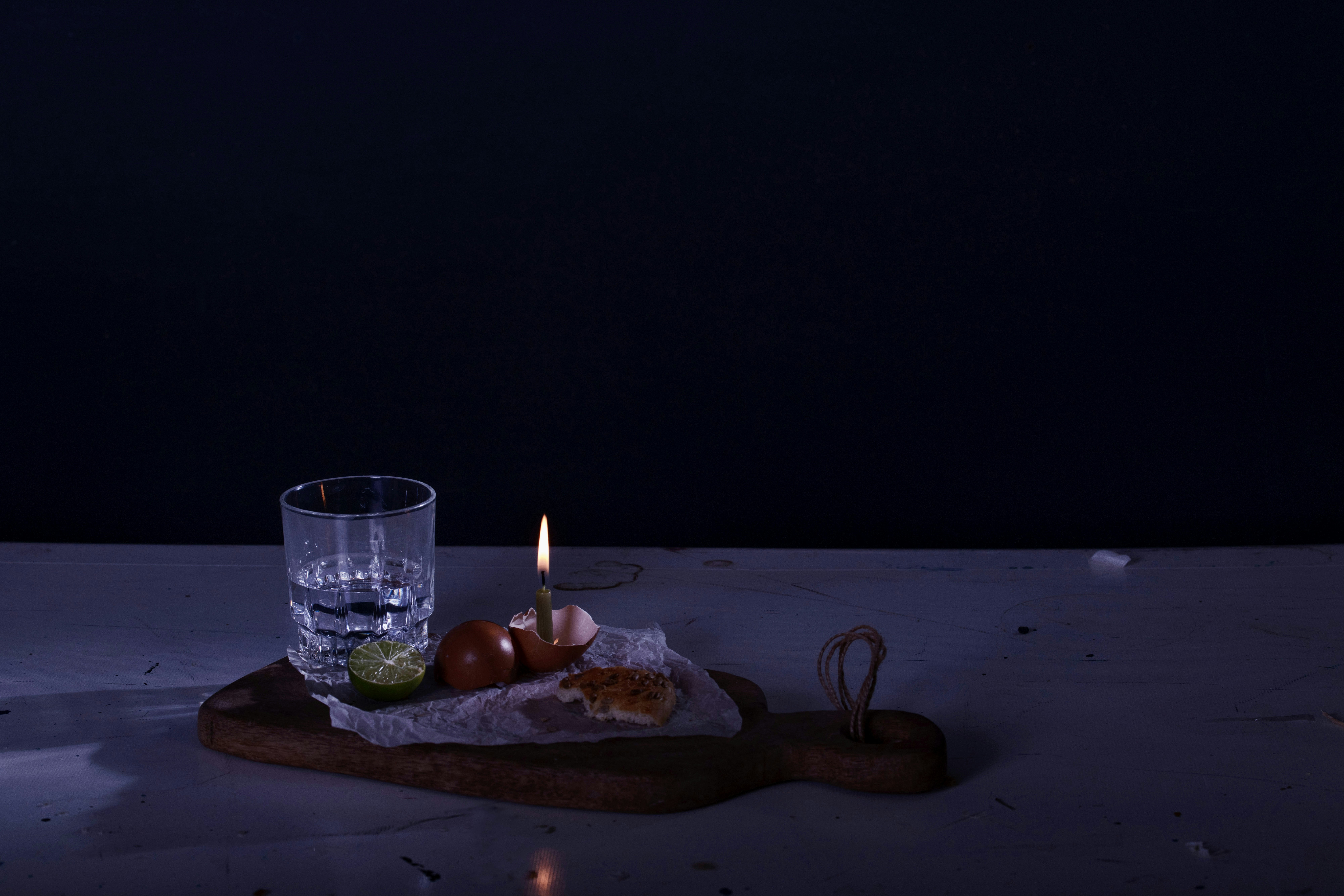 A Quiet Candlelit Spread on a Wooden Board