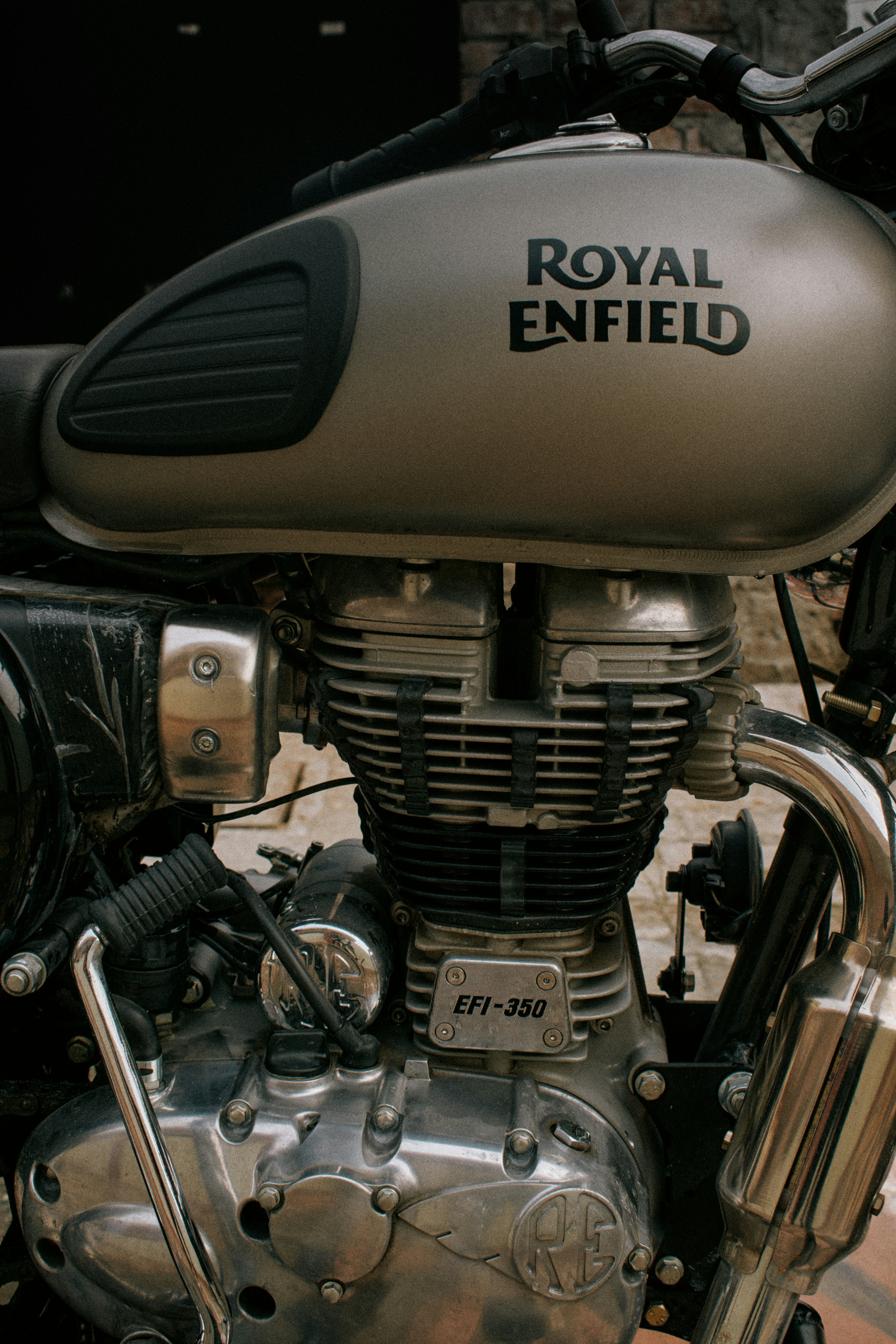 Close-up of a Royal Enfield motorcycle engine showcasing intricate mechanical details and branding.