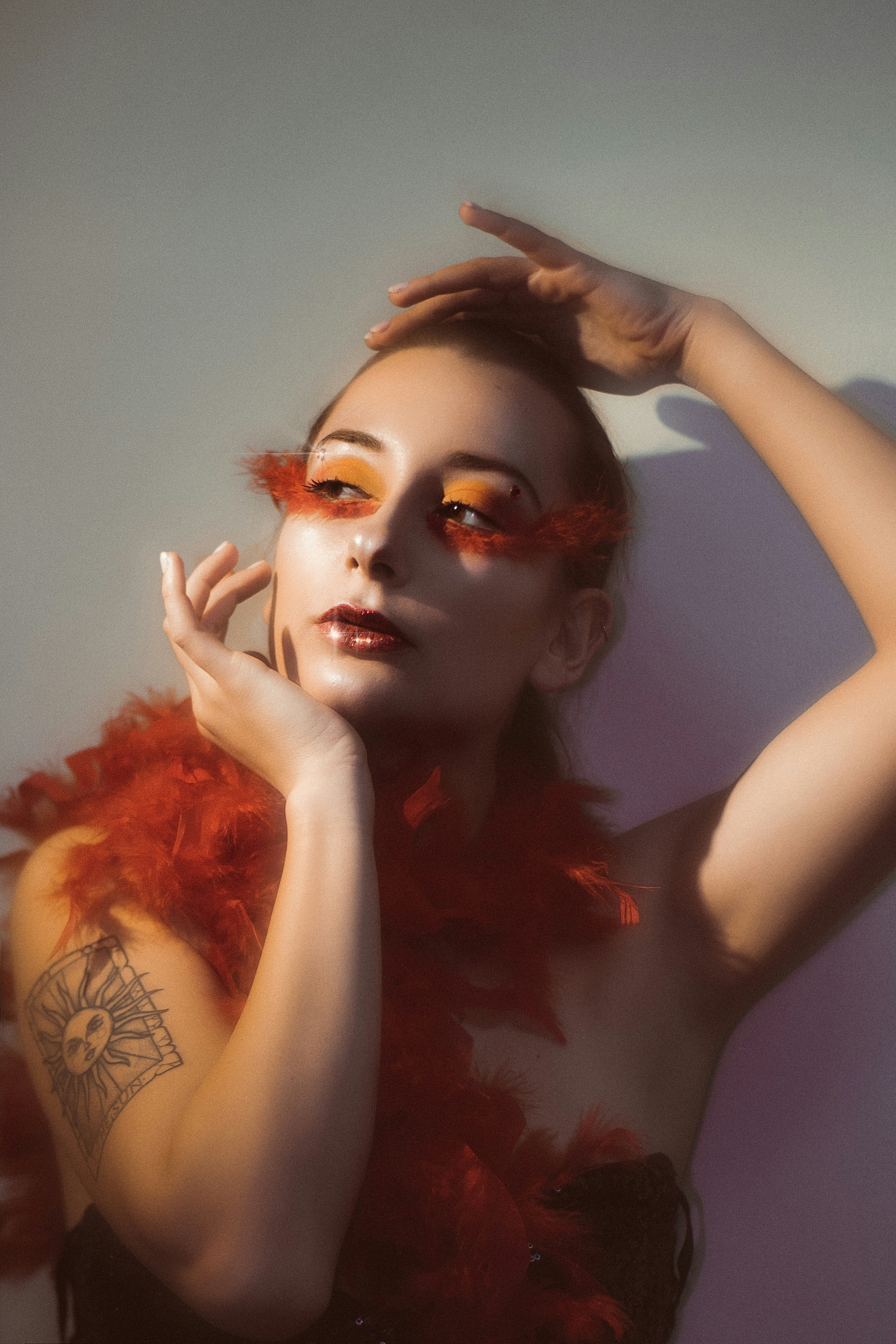 A woman with a red feather around her neck photo – Free Skin Image on ...